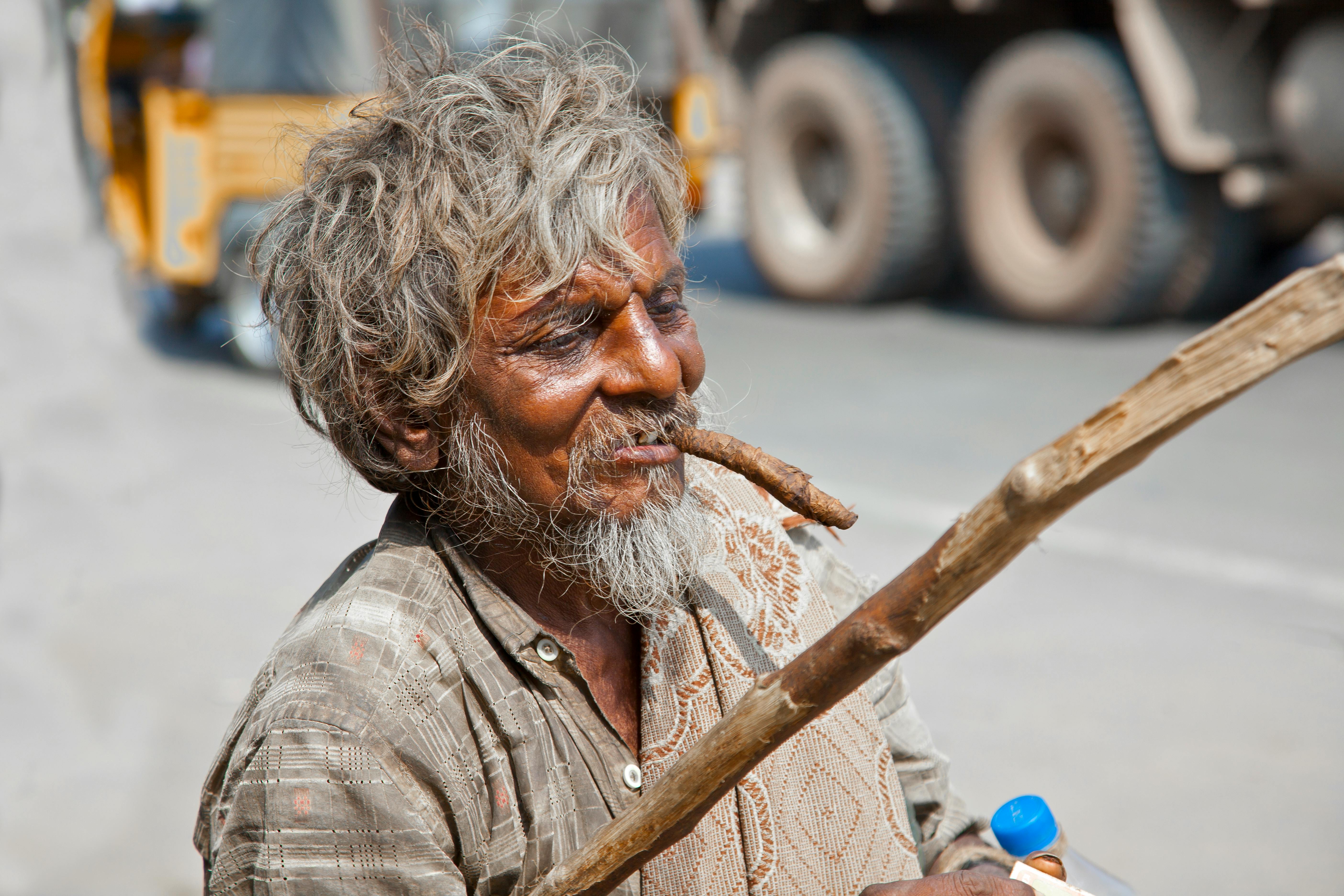 A Homeless Man holding Wood · Free Stock Photo