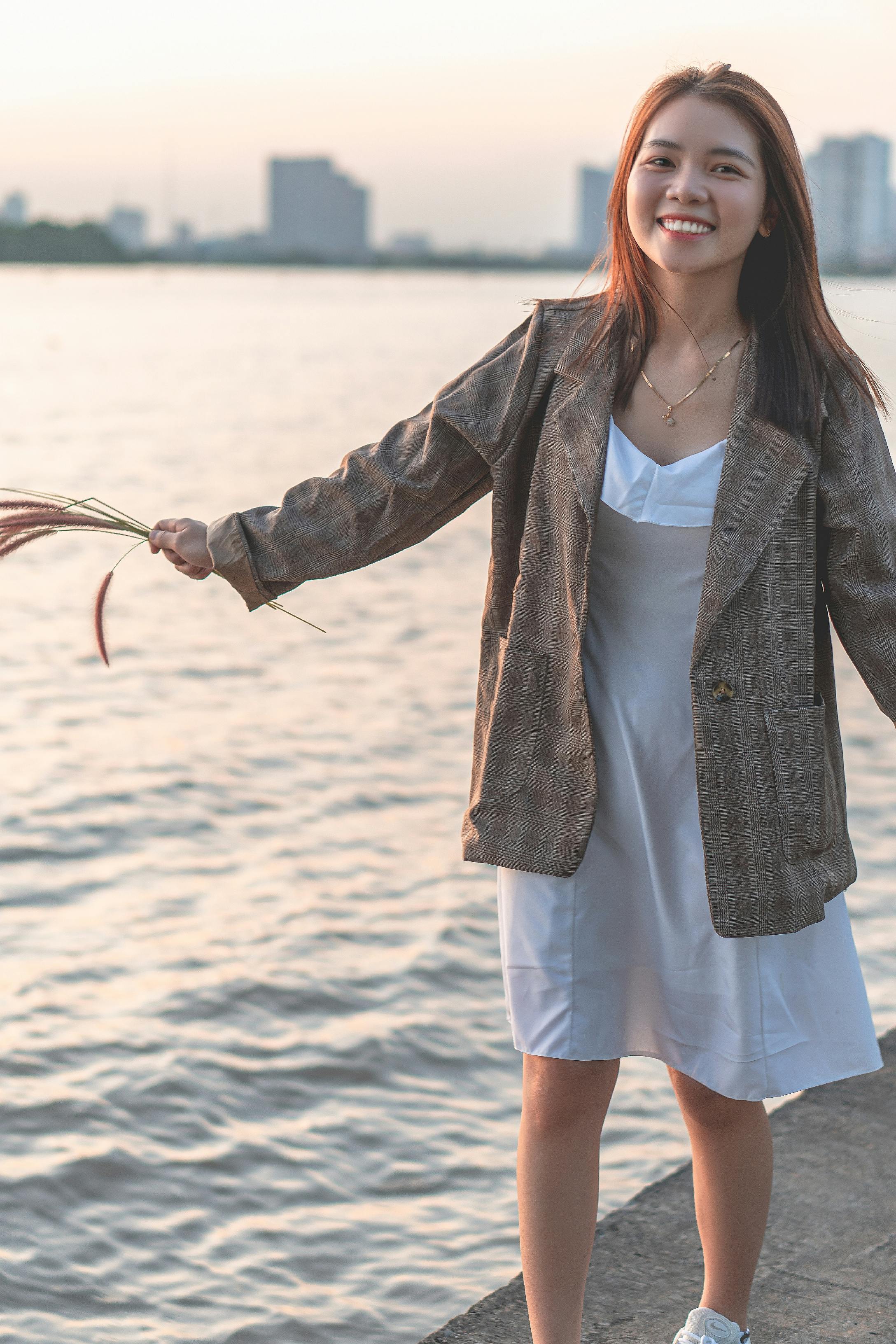 A Woman Wearing a Jacket over a White Dress · Free Stock Photo