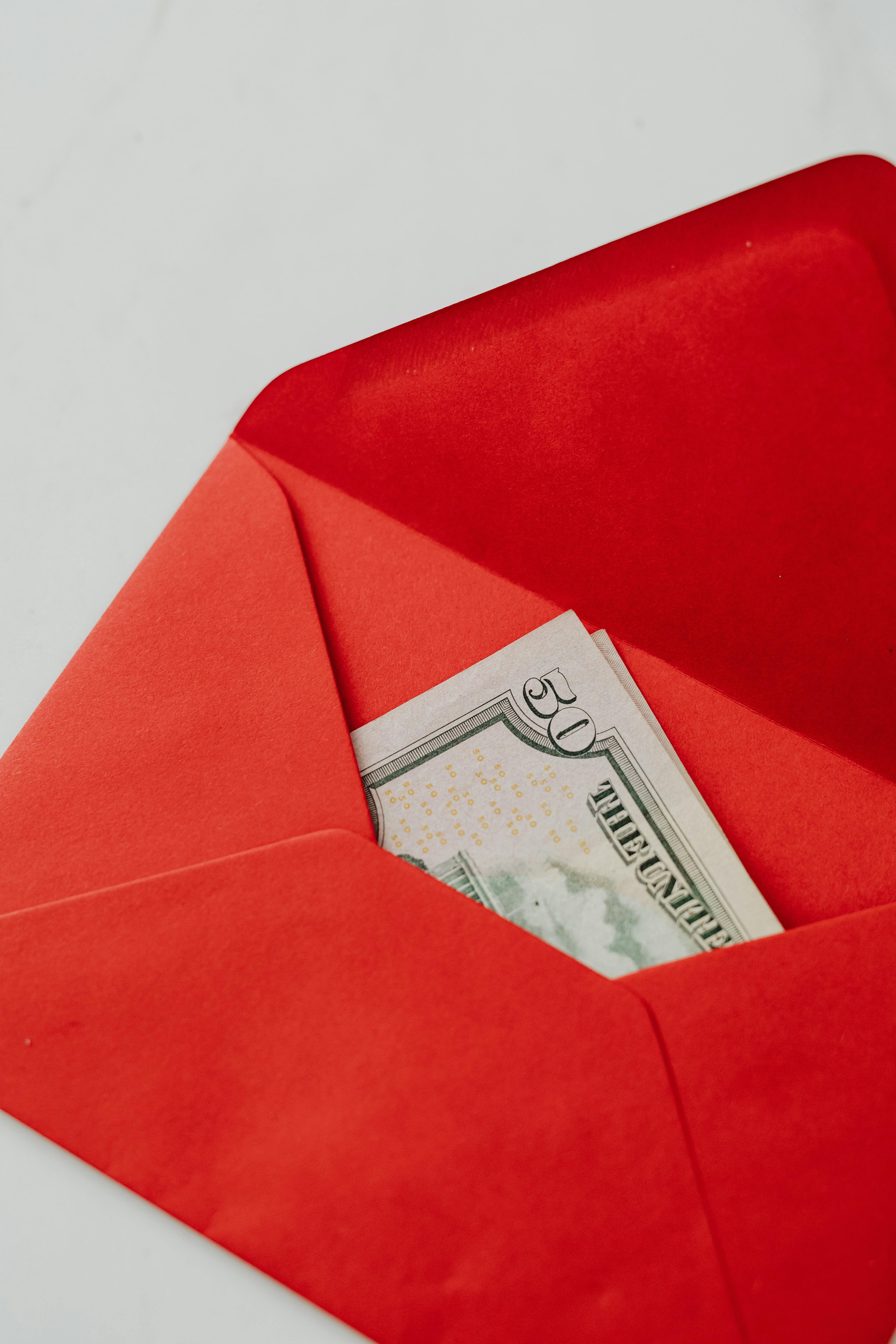 Open Red Envelope with Dollar Bills Inside · Free Stock Photo