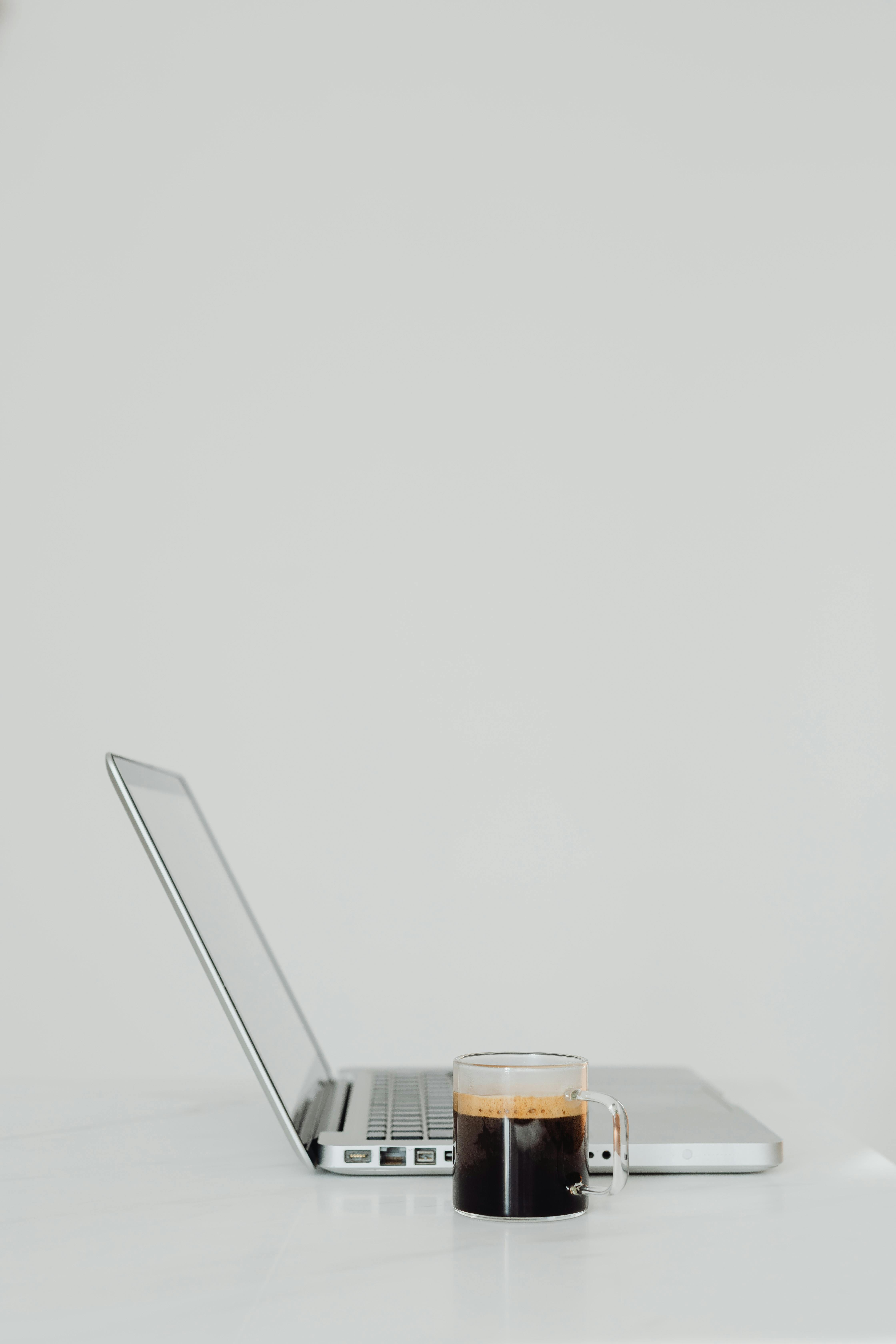 A Cup of Black Coffee Beside a Laptop · Free Stock Photo