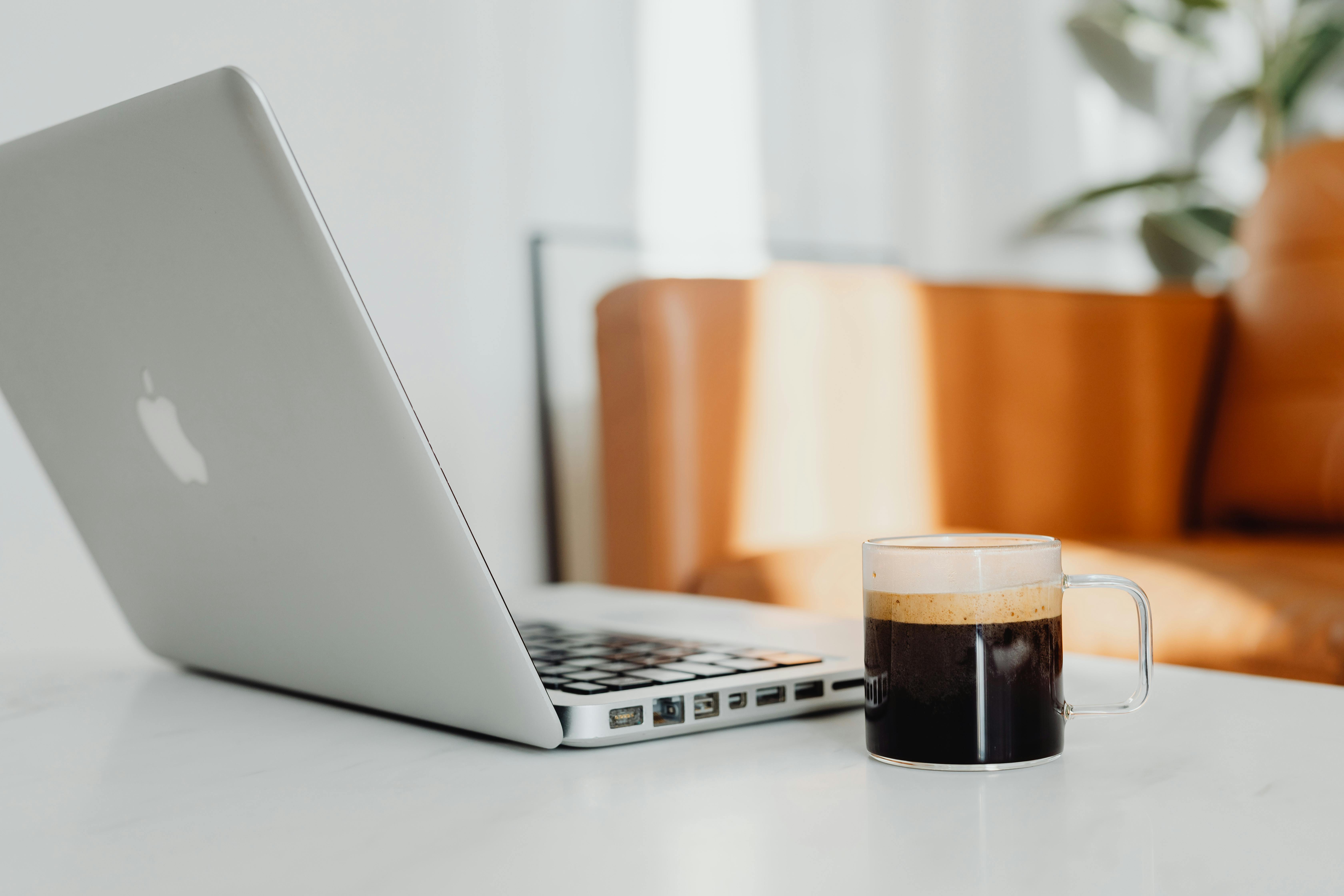 A Cup of Coffee beside a Laptop · Free Stock Photo