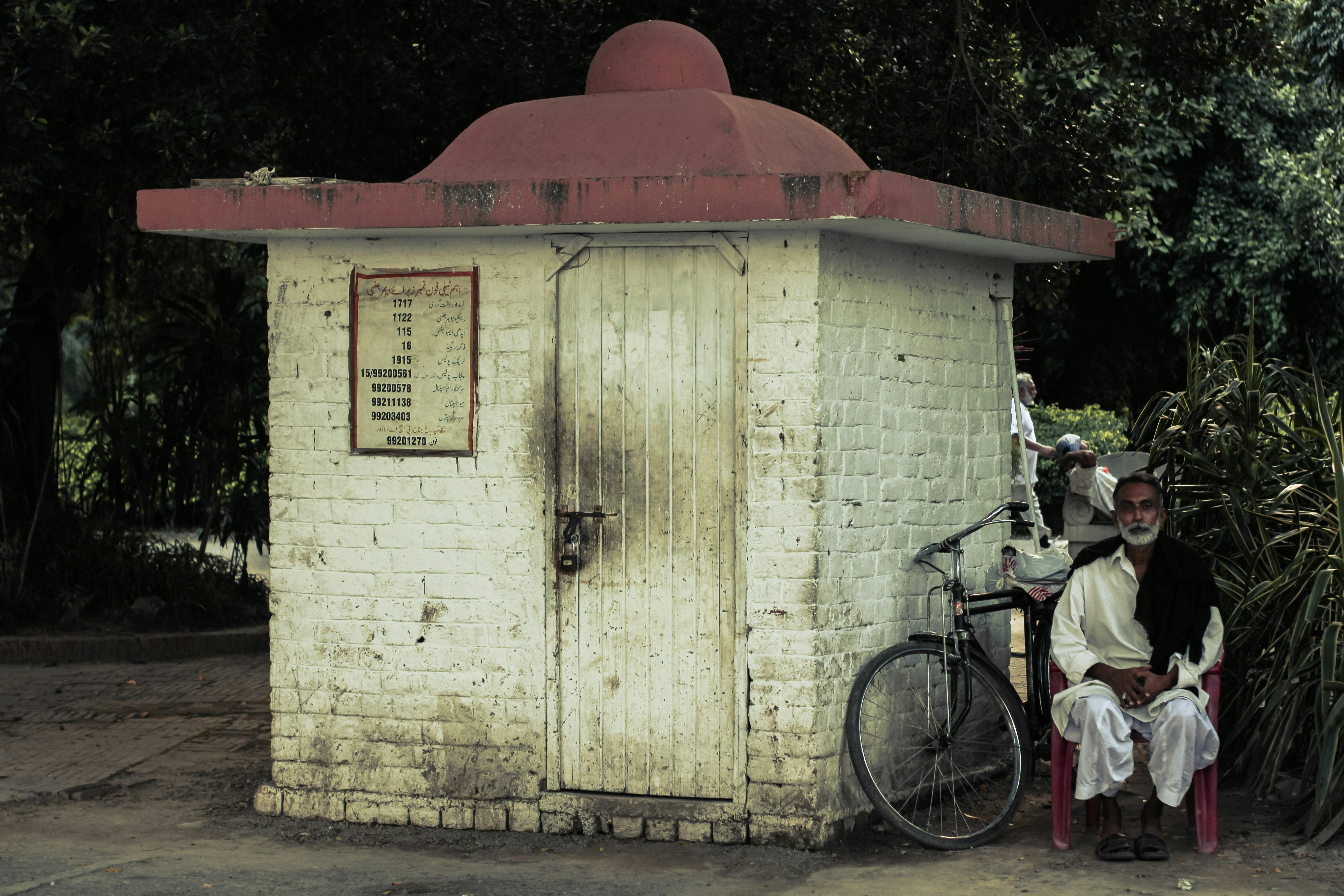 Elderly Man Cooking Over Fire on a Makeshift Stove · Free Stock Photo