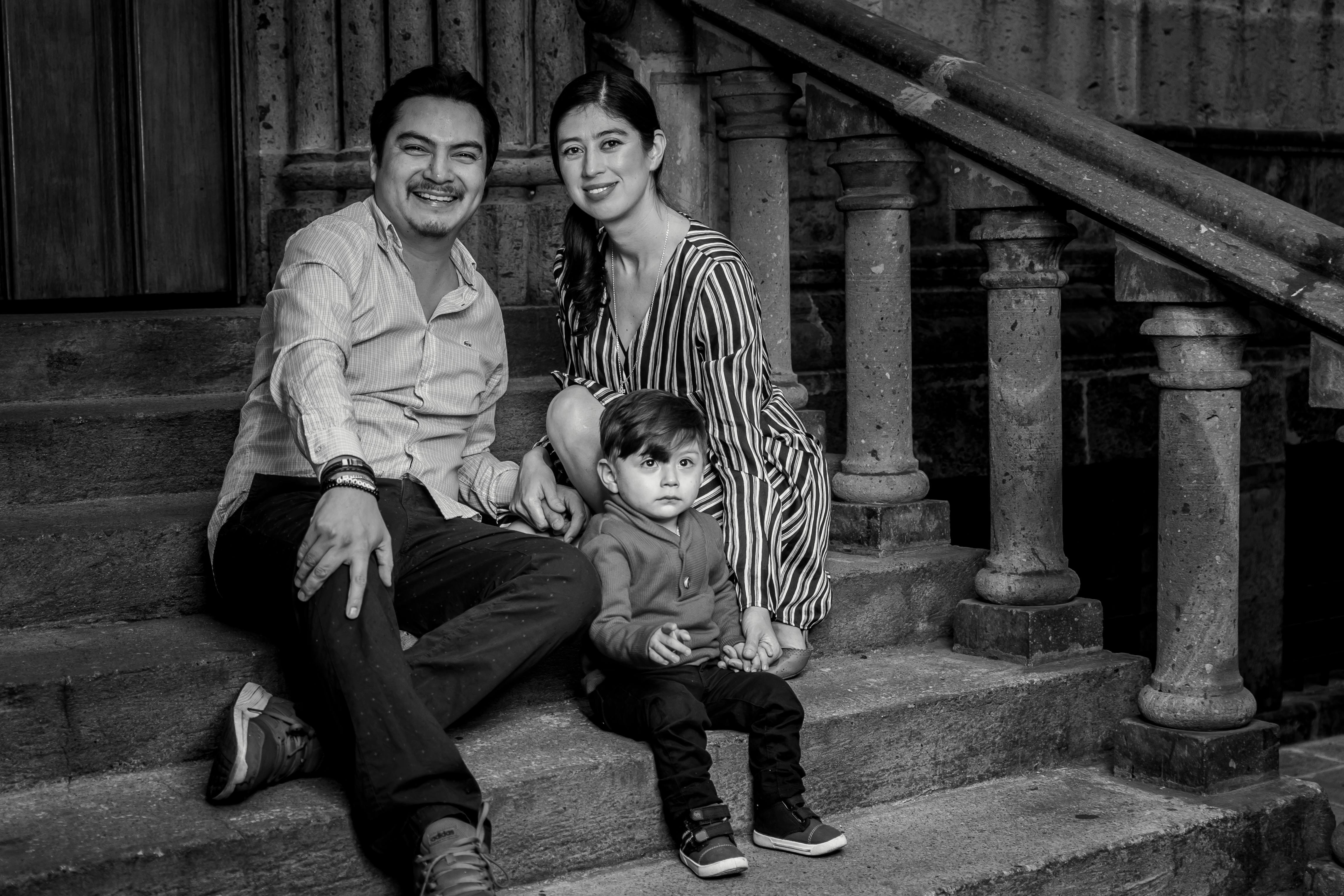 Grayscale Photo of a Happy Family Sitting on a Concrete Stairs · Free ...