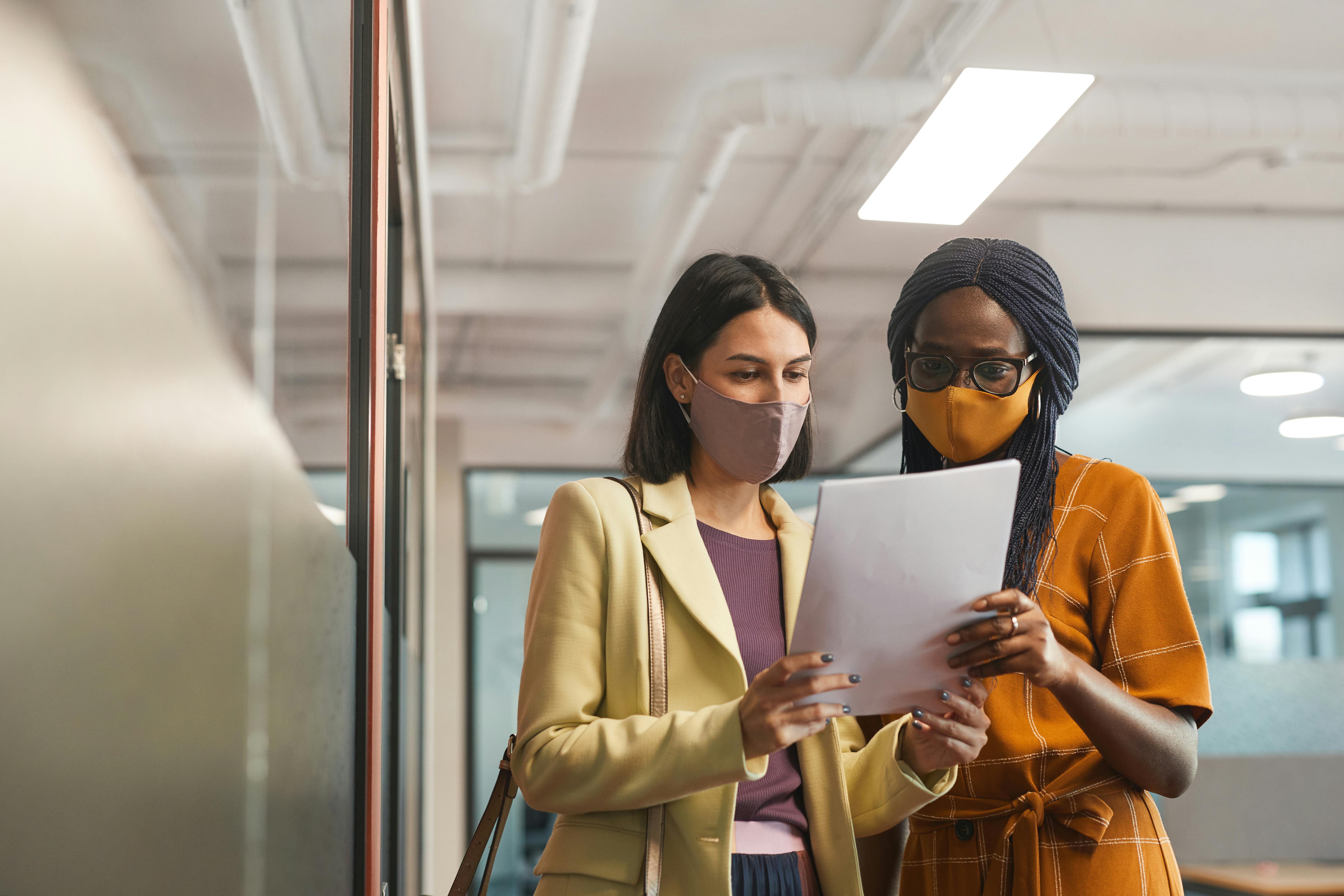 Two Women Holding Documents · Free Stock Photo