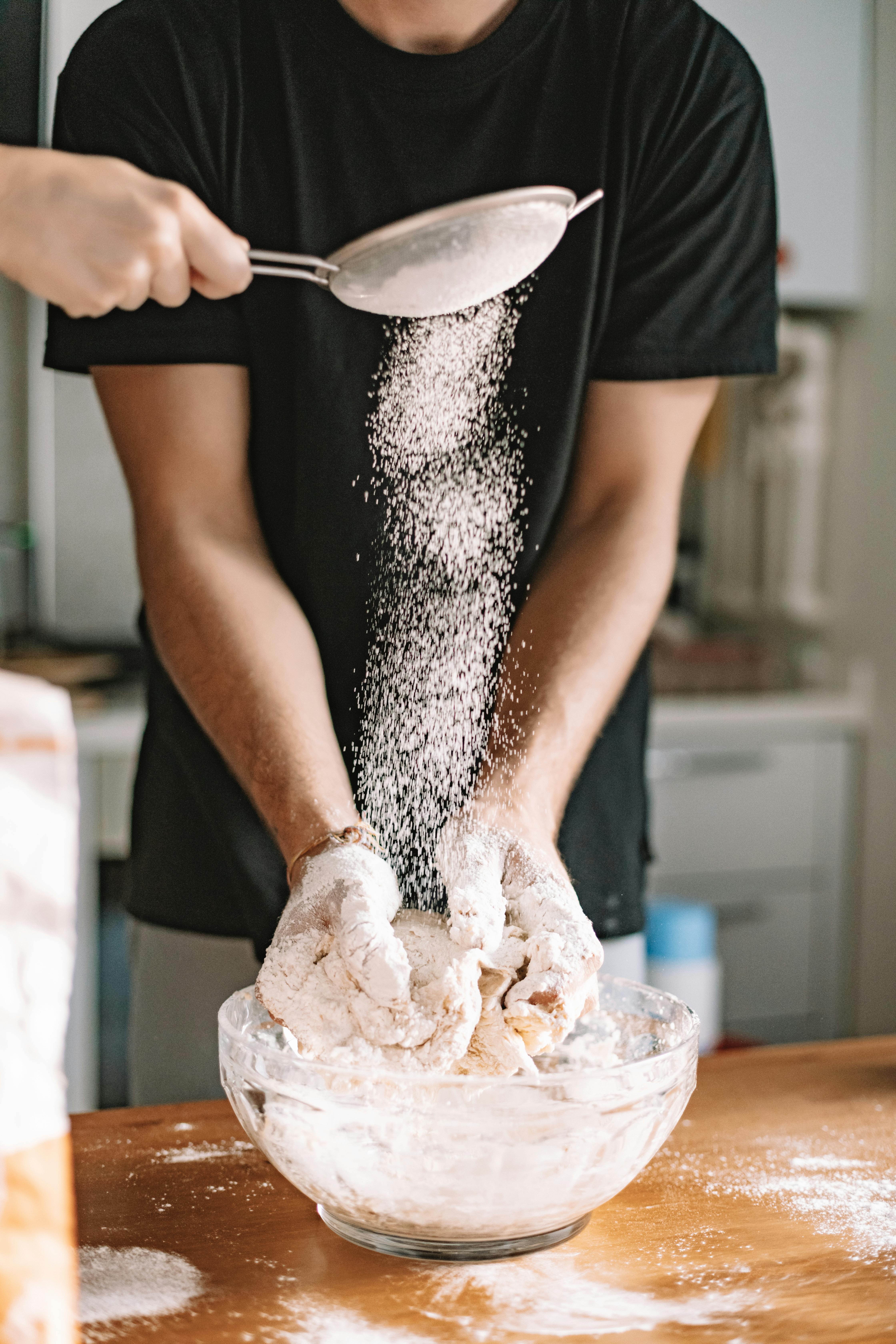 Person in Black Top with Flour on Hands · Free Stock Photo