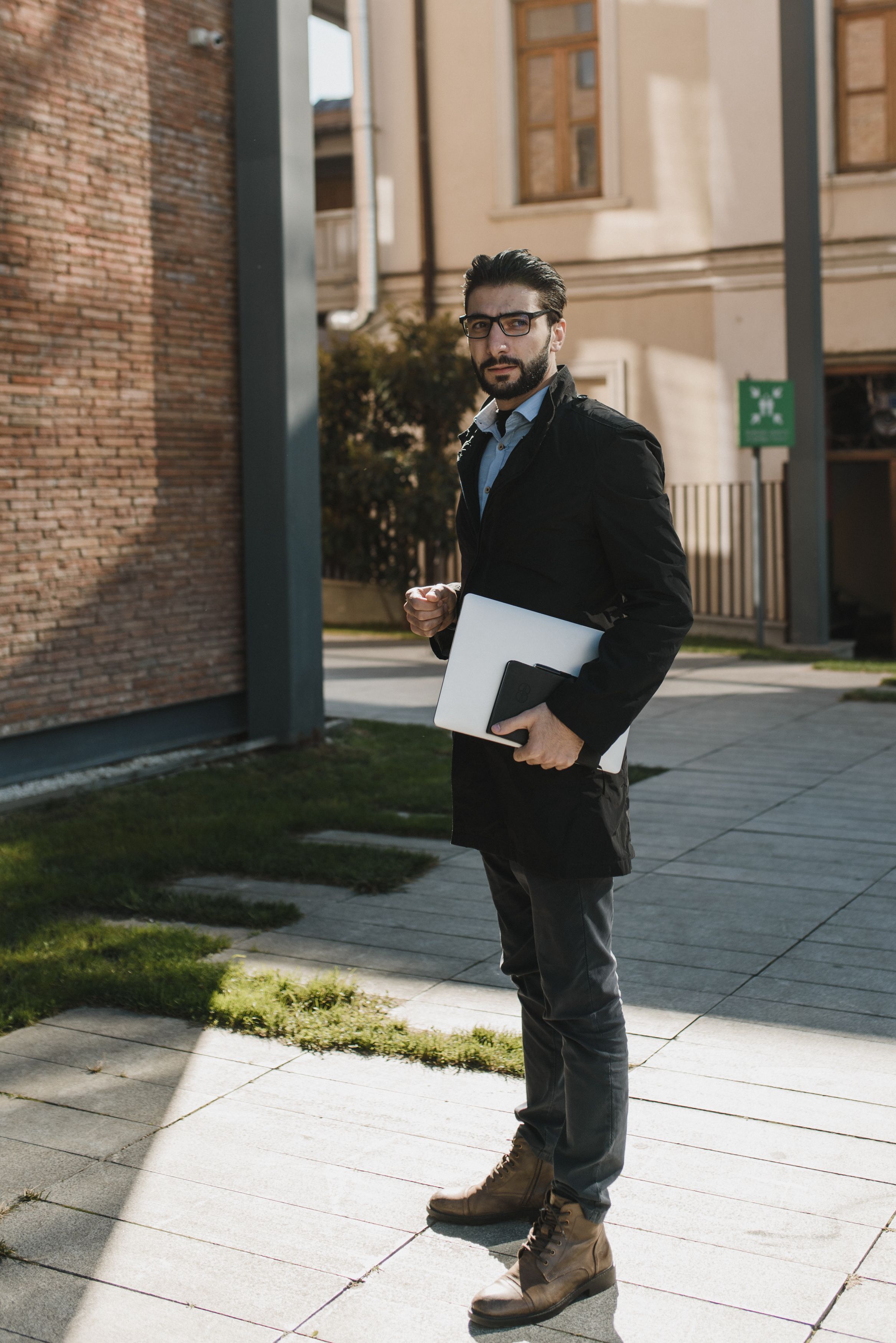 Man Wearing a Black Jacket Standing on Walkway · Free Stock Photo