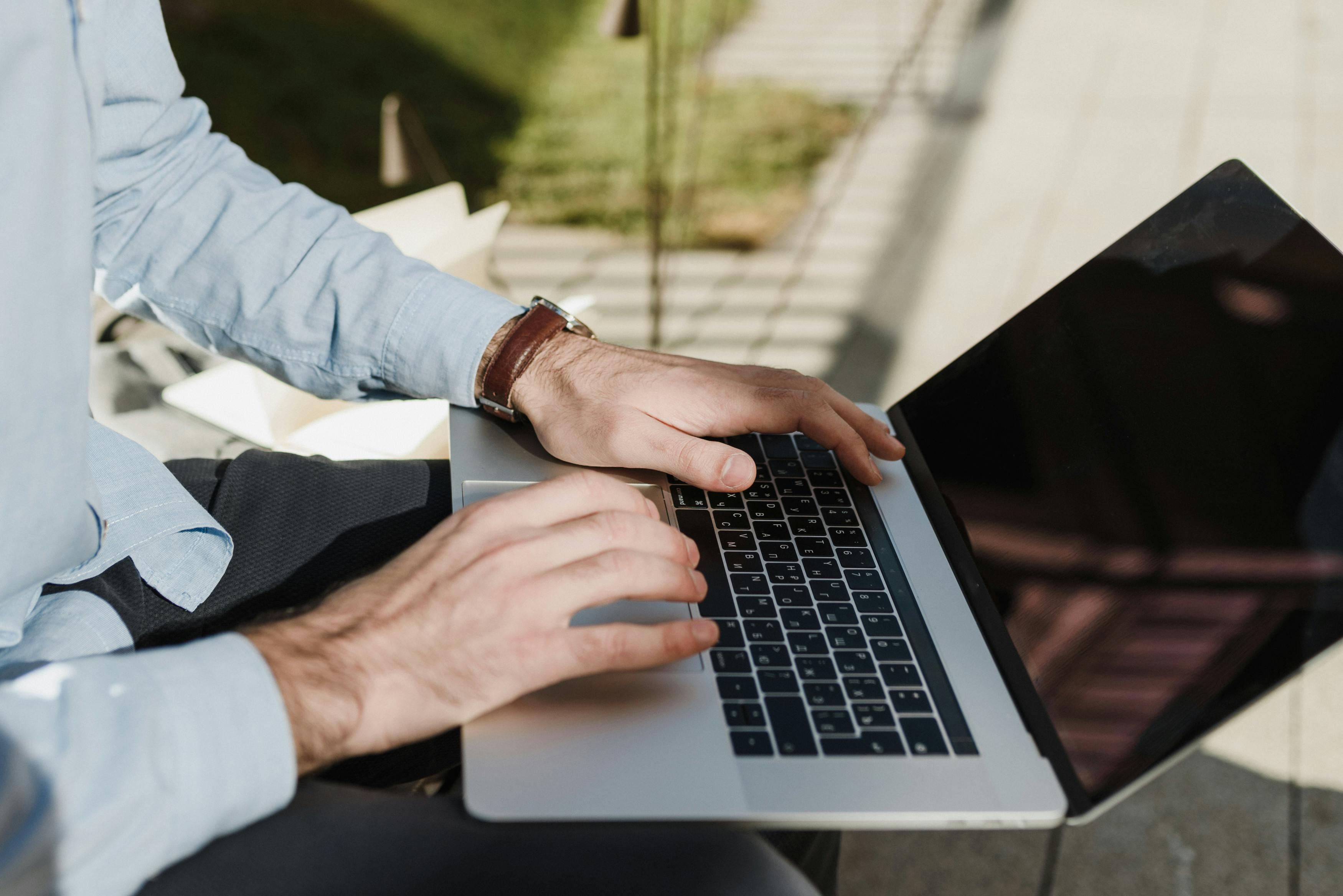 A Man Sitting with a Laptop on His Lap · Free Stock Photo