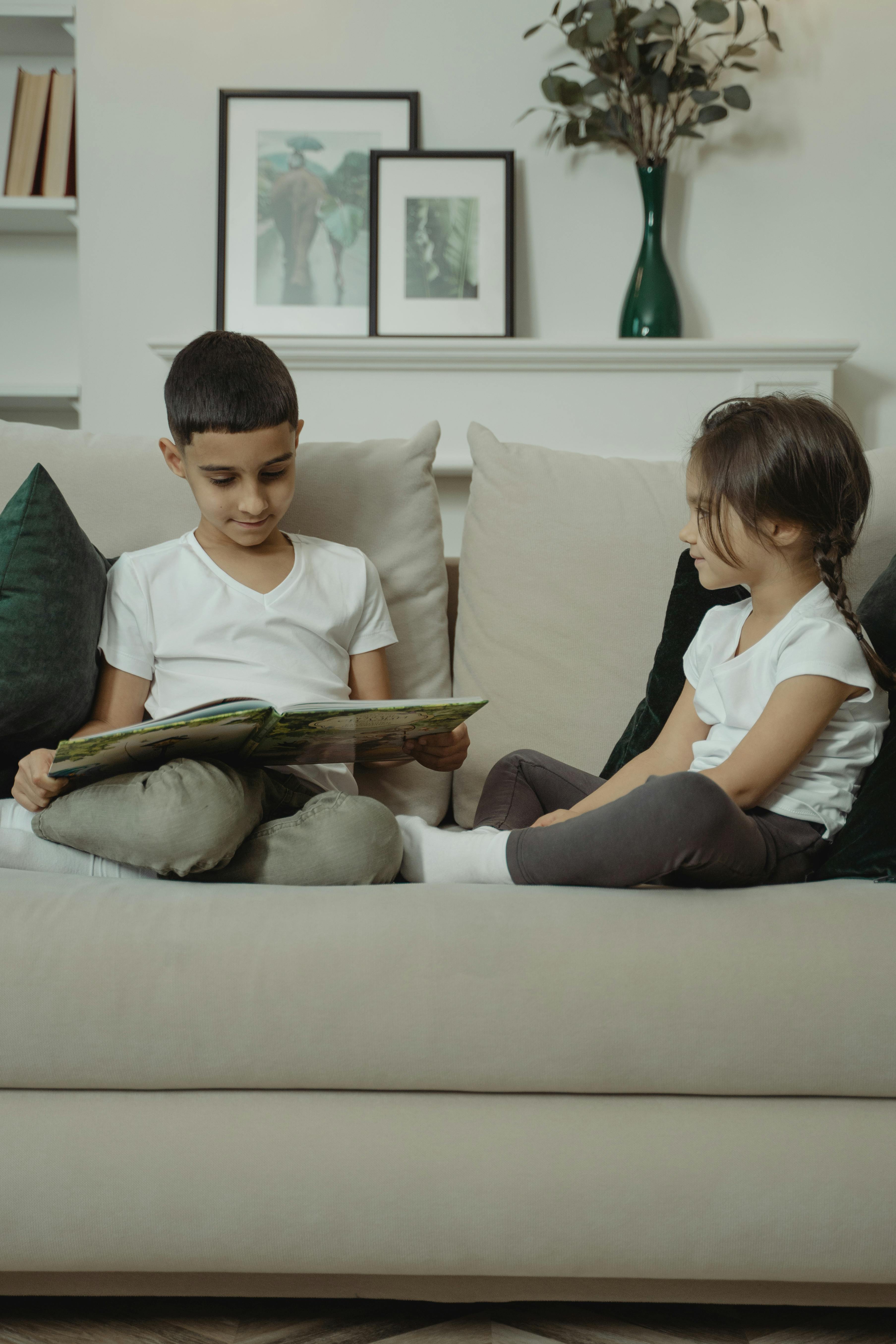 Siblings Reading a Book Together · Free Stock Photo