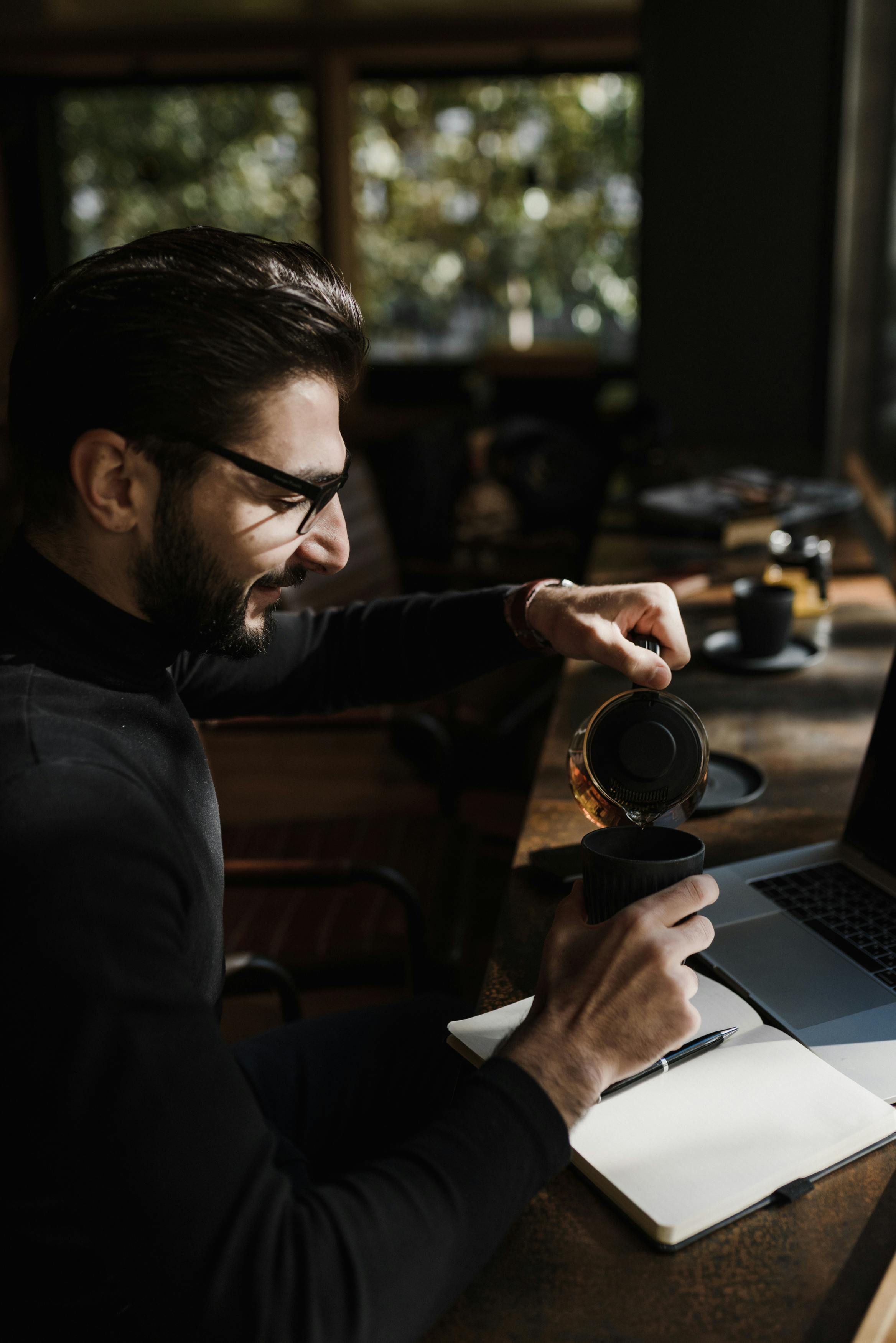 A Man Pouring Tea in the Cup · Free Stock Photo