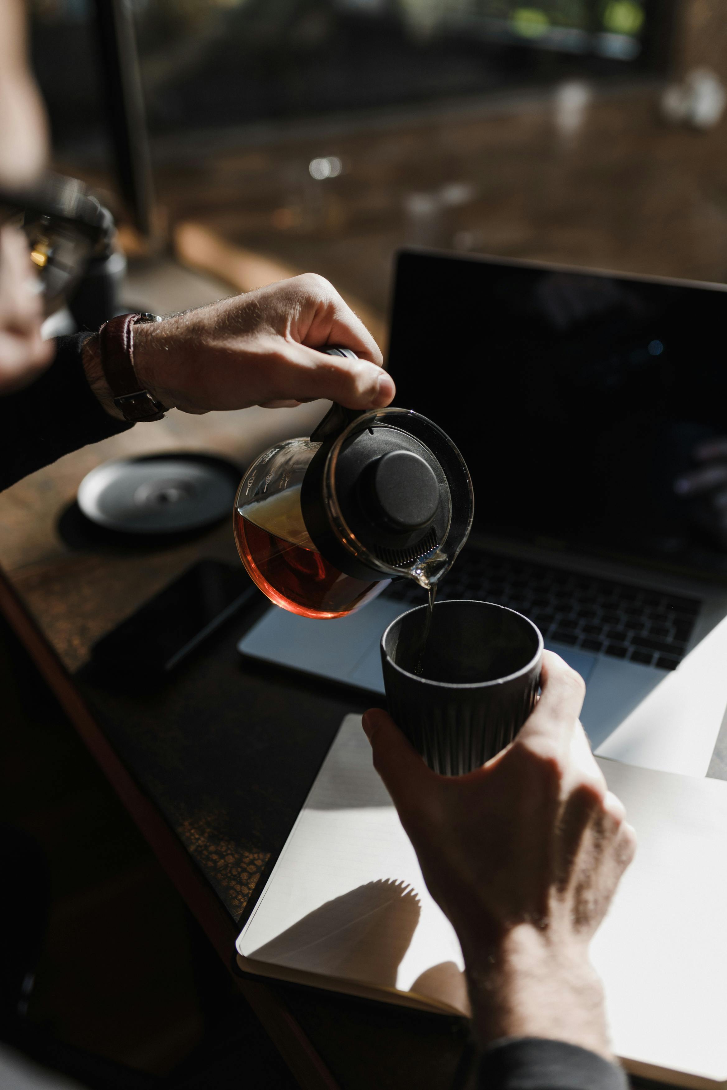 A Person Pouring Tea in the Cup · Free Stock Photo
