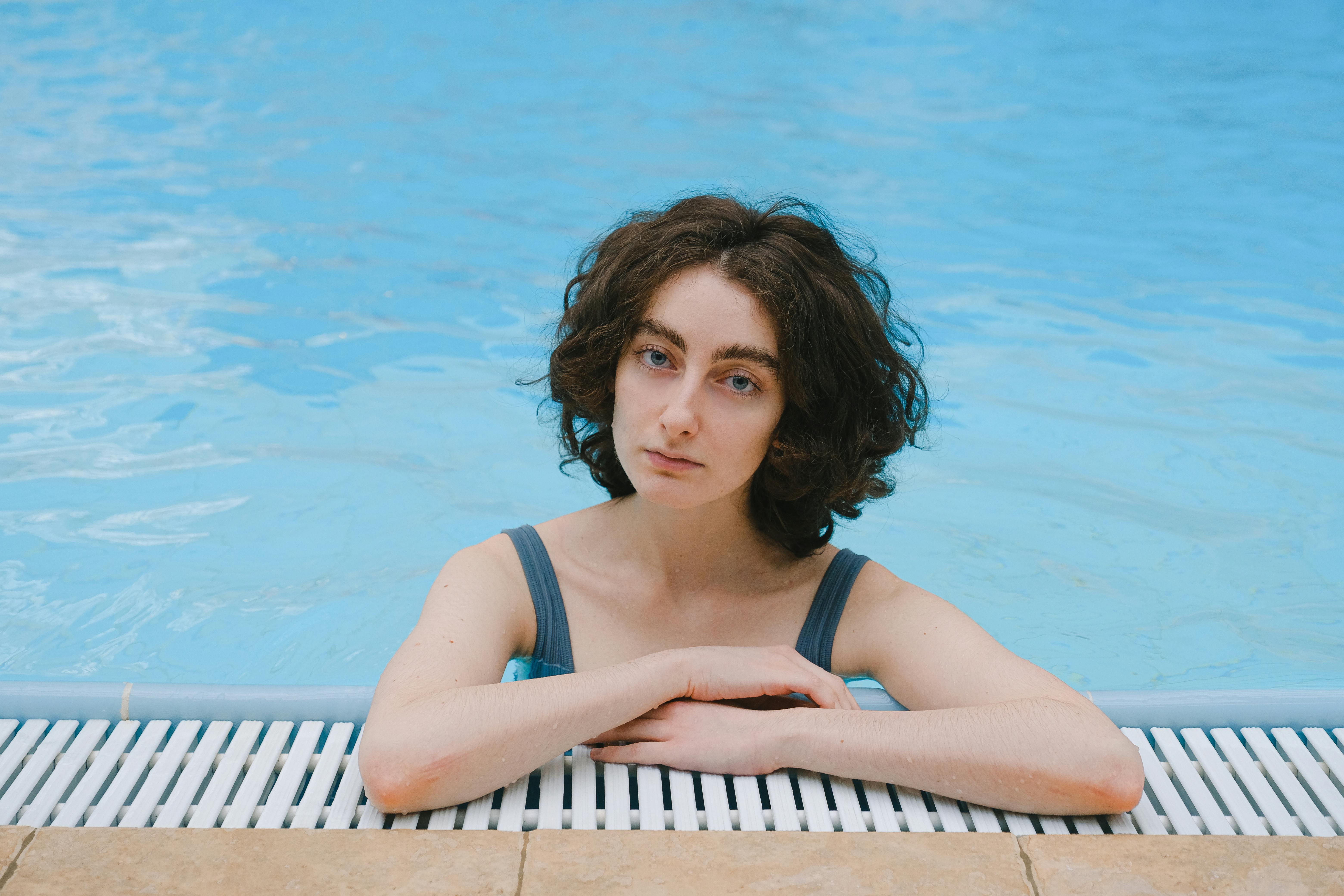 Photo Of Person Near Swimming Pool · Free Stock Photo