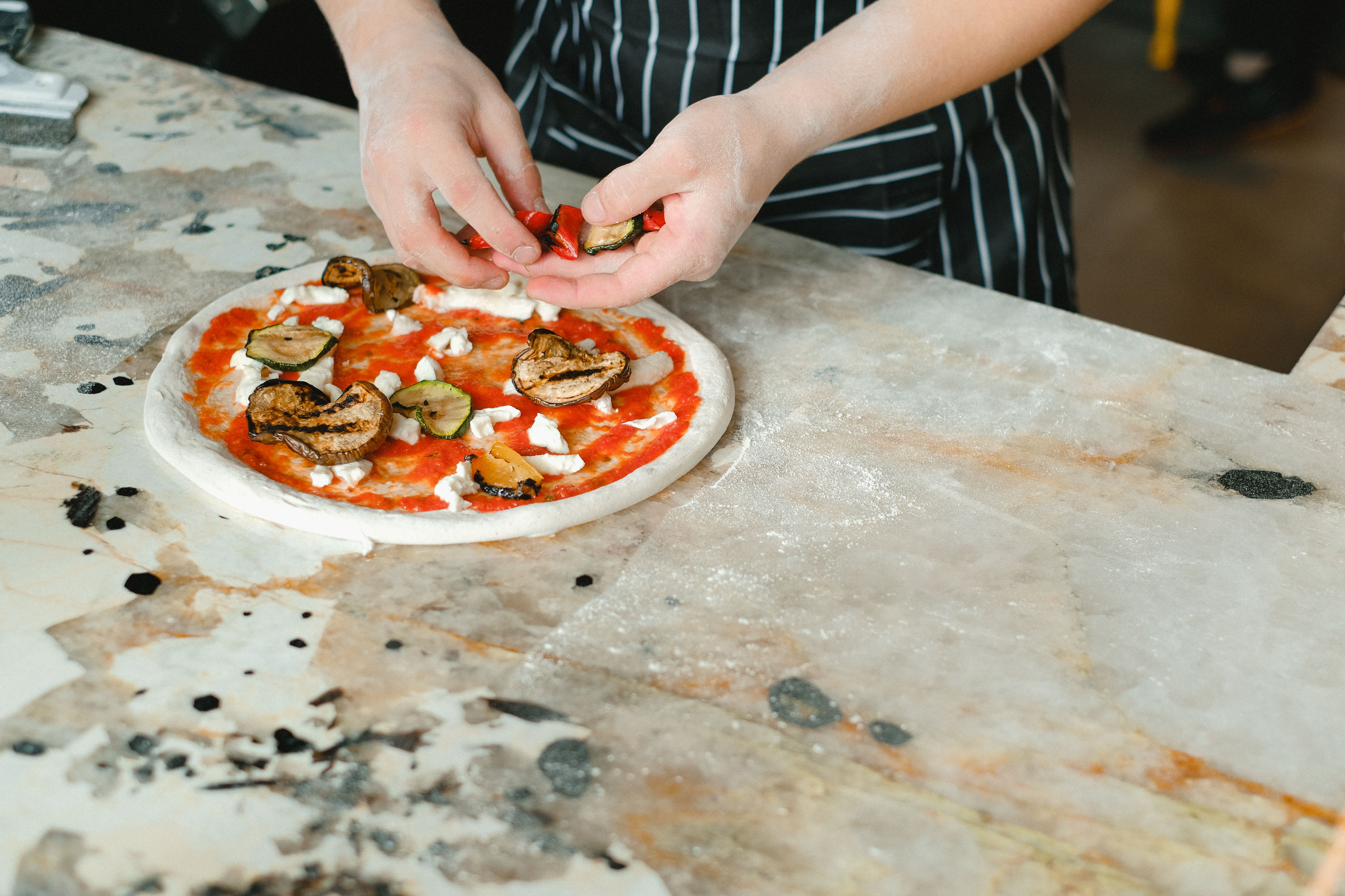 A Chef Toppings Pizza with Vegetables · Free Stock Photo