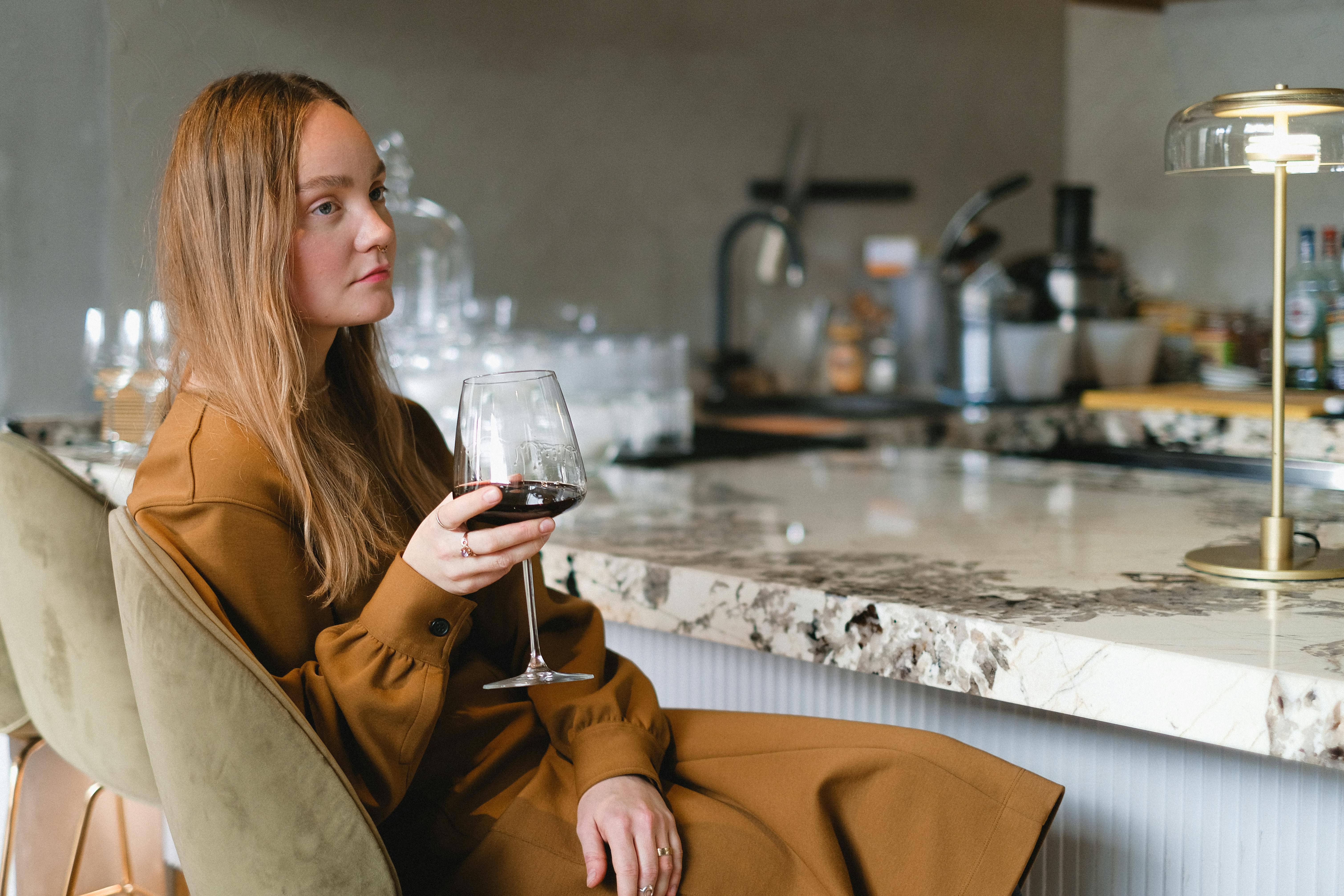 A Woman Sitting on Bar Stool Chair · Free Stock Photo