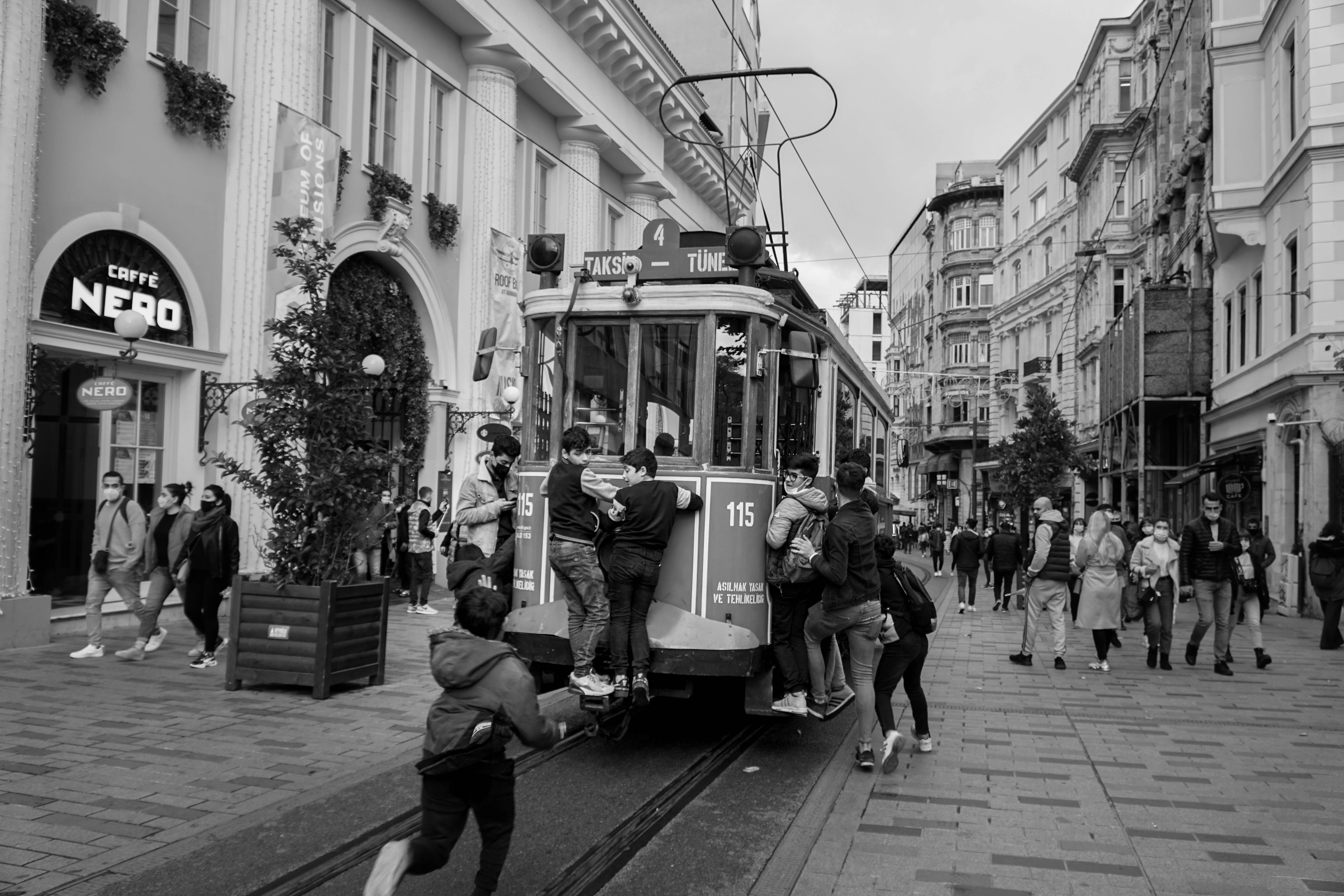 Grayscale Photo of People Riding on Tram · Free Stock Photo