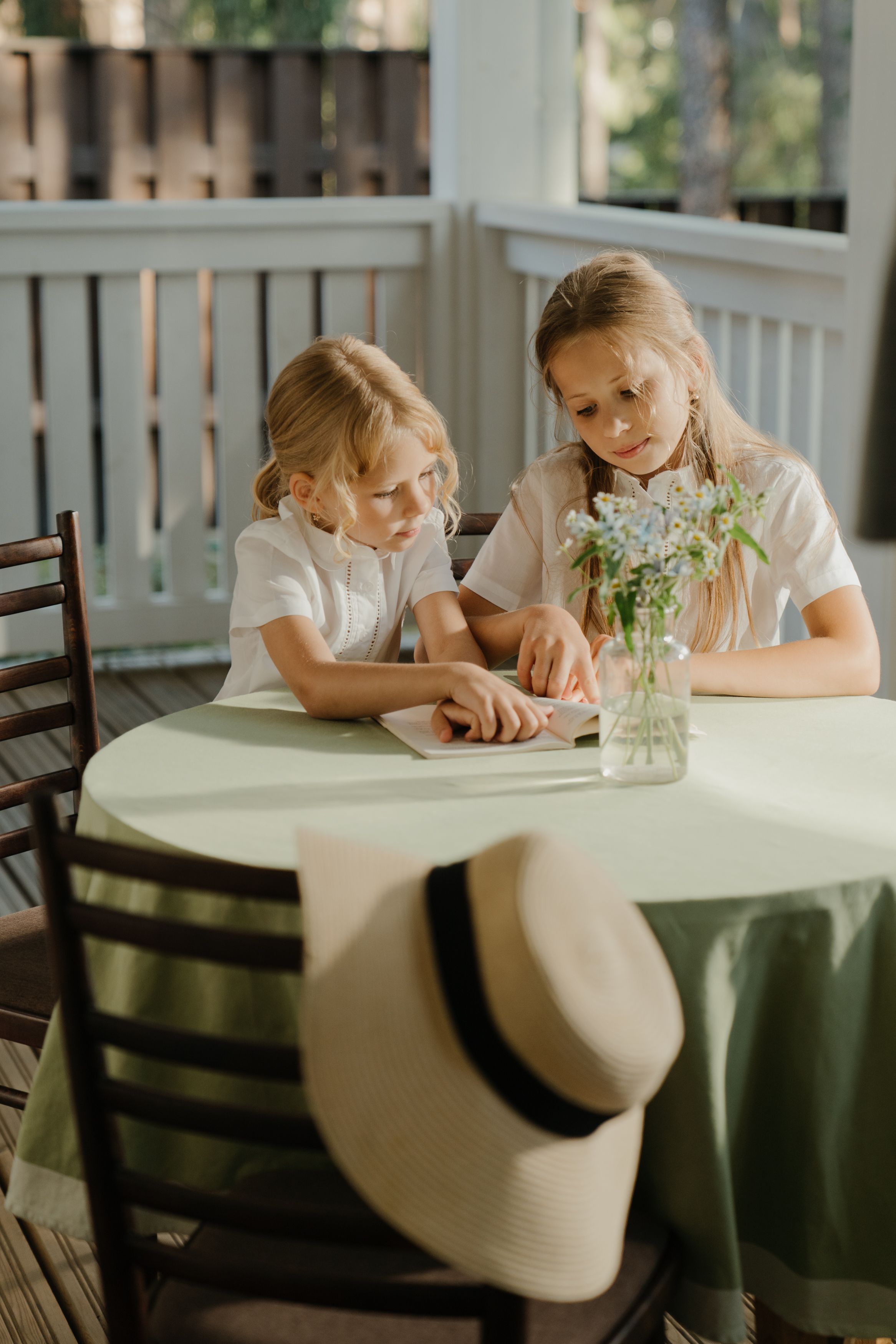 Children Reading a Book on a Table · Free Stock Photo