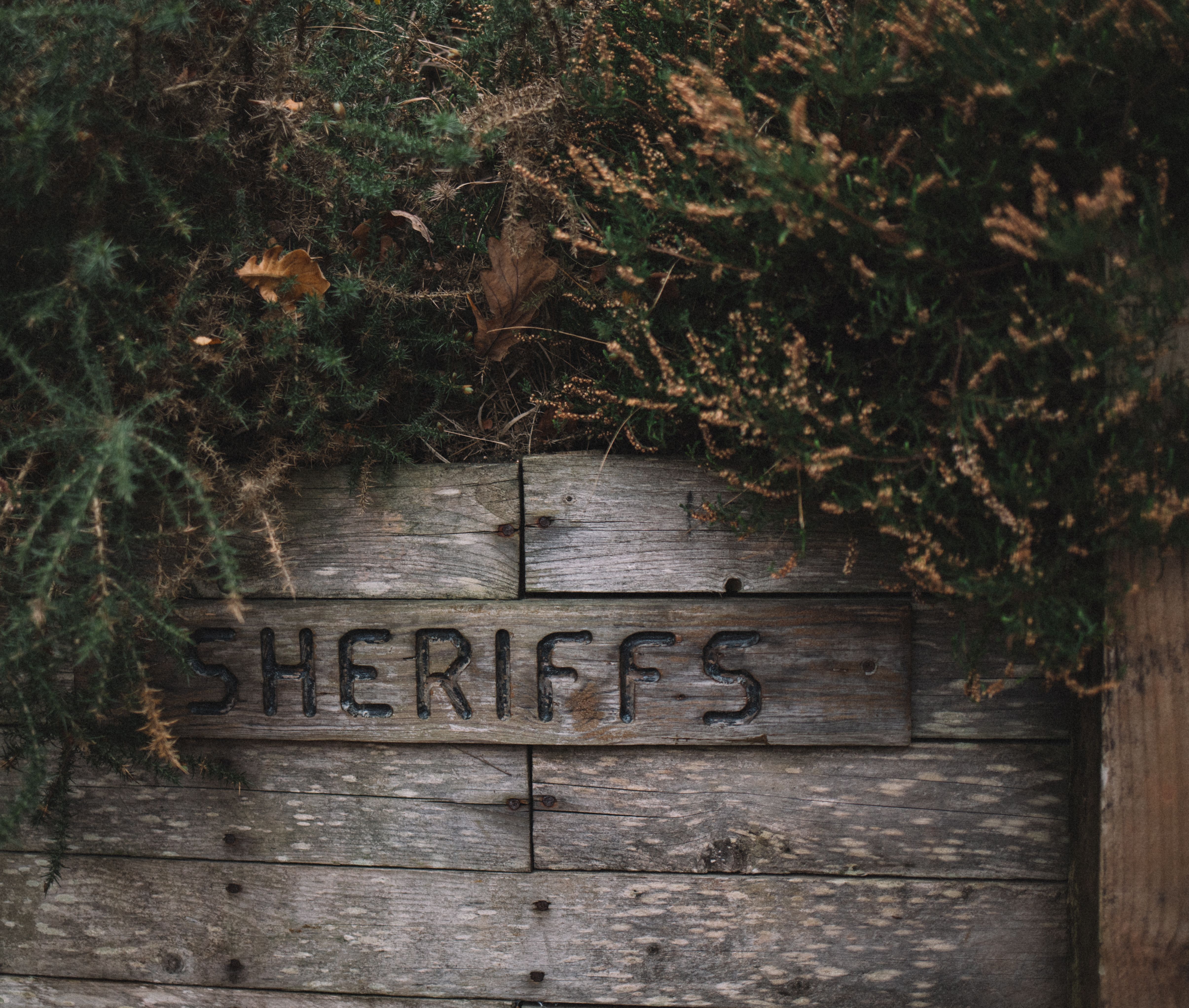 Wooden Fence with Sheriffs Sign · Free Stock Photo