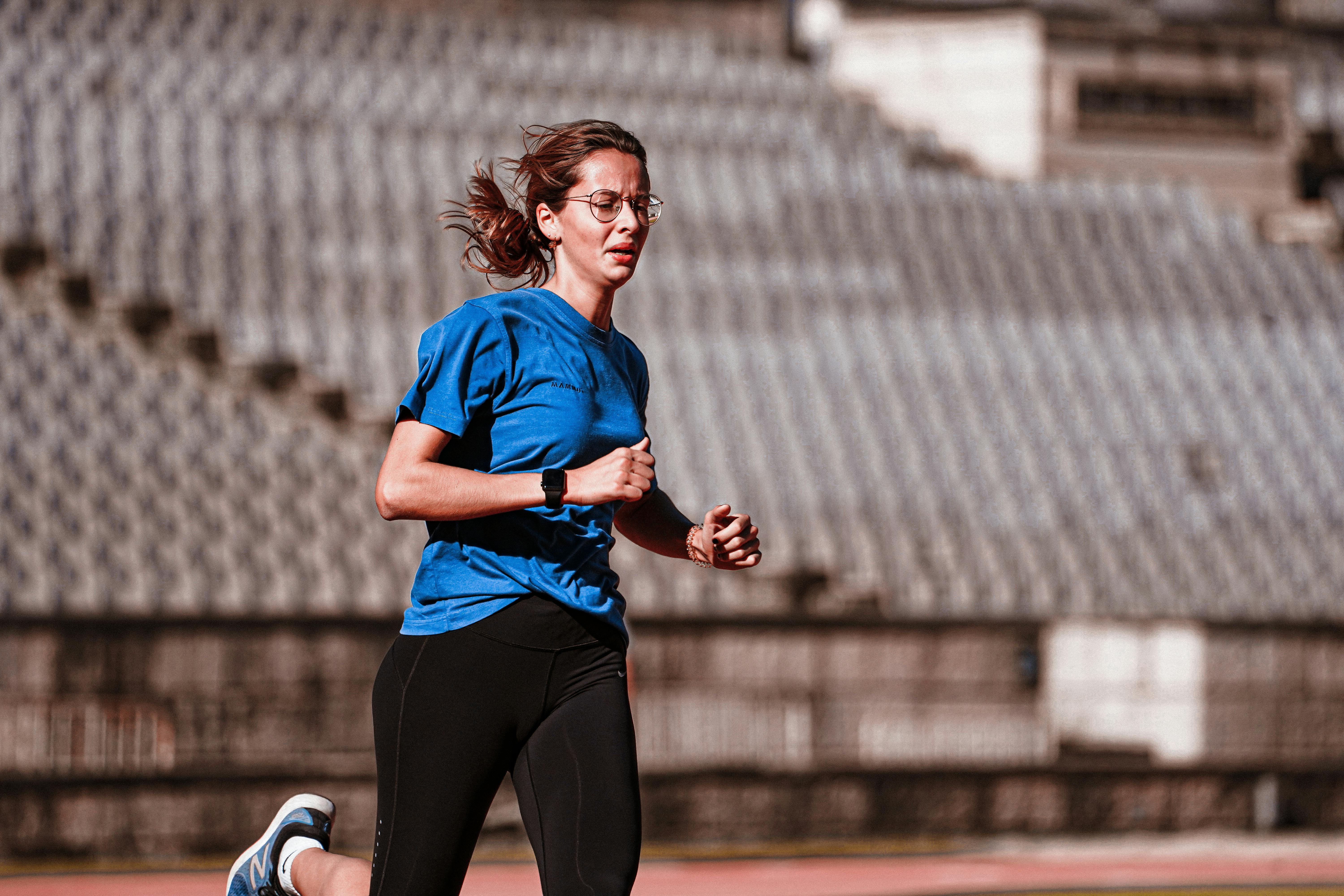 Woman Running on a Running Track · Free Stock Photo