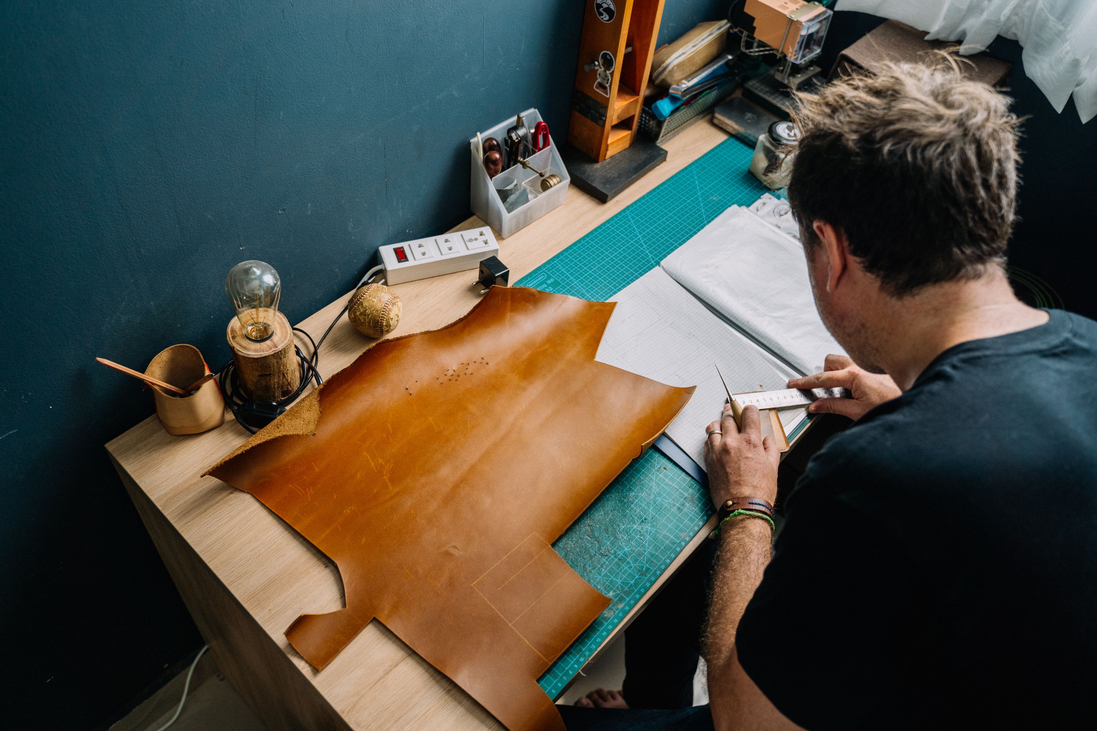 A Close-Up Shot of a Leatherworker Using a Stitching Awl · Free Stock Photo