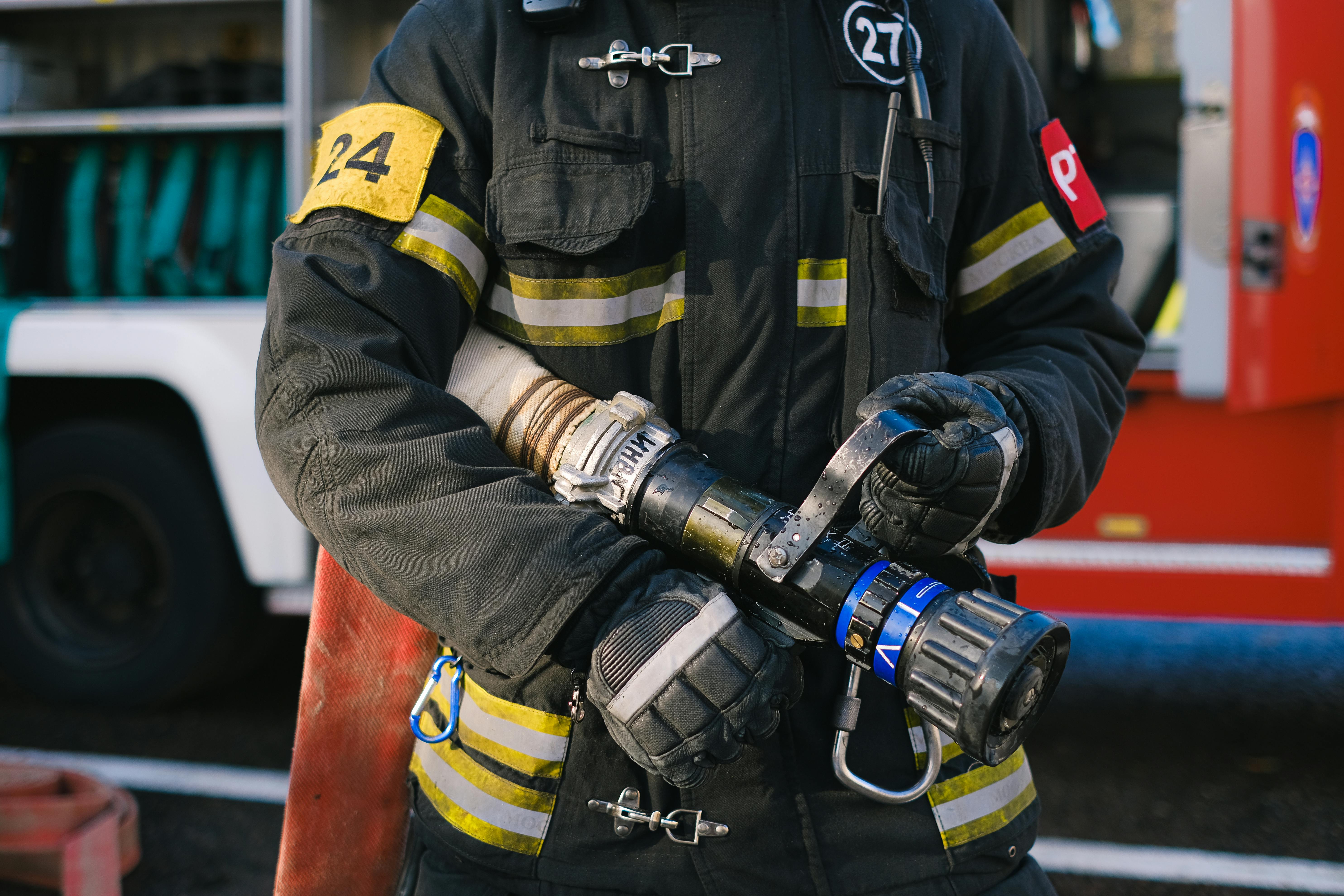 Fireman Holding a Hose · Free Stock Photo