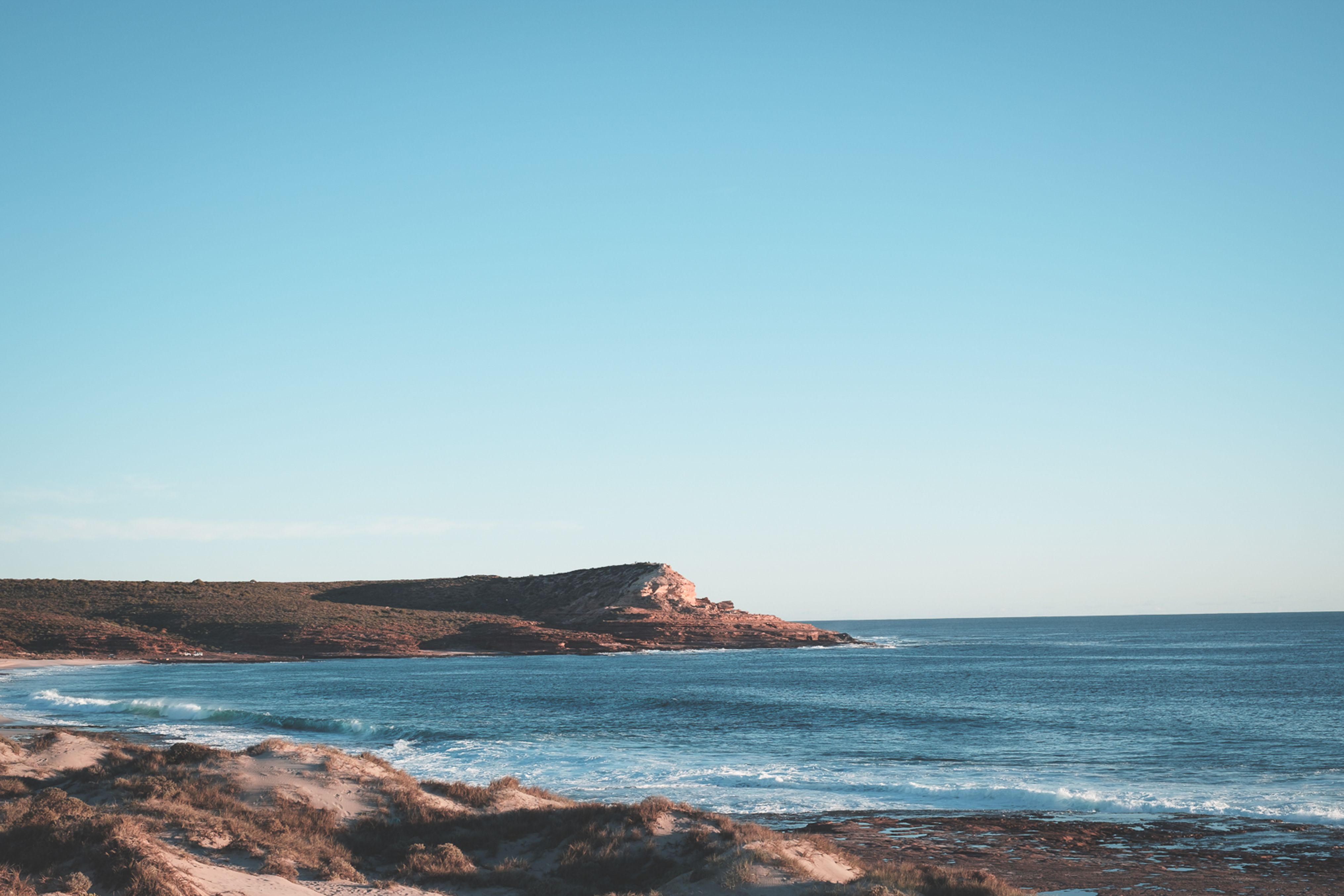 Endless blue sea with rippling water washing shore · Free Stock Photo