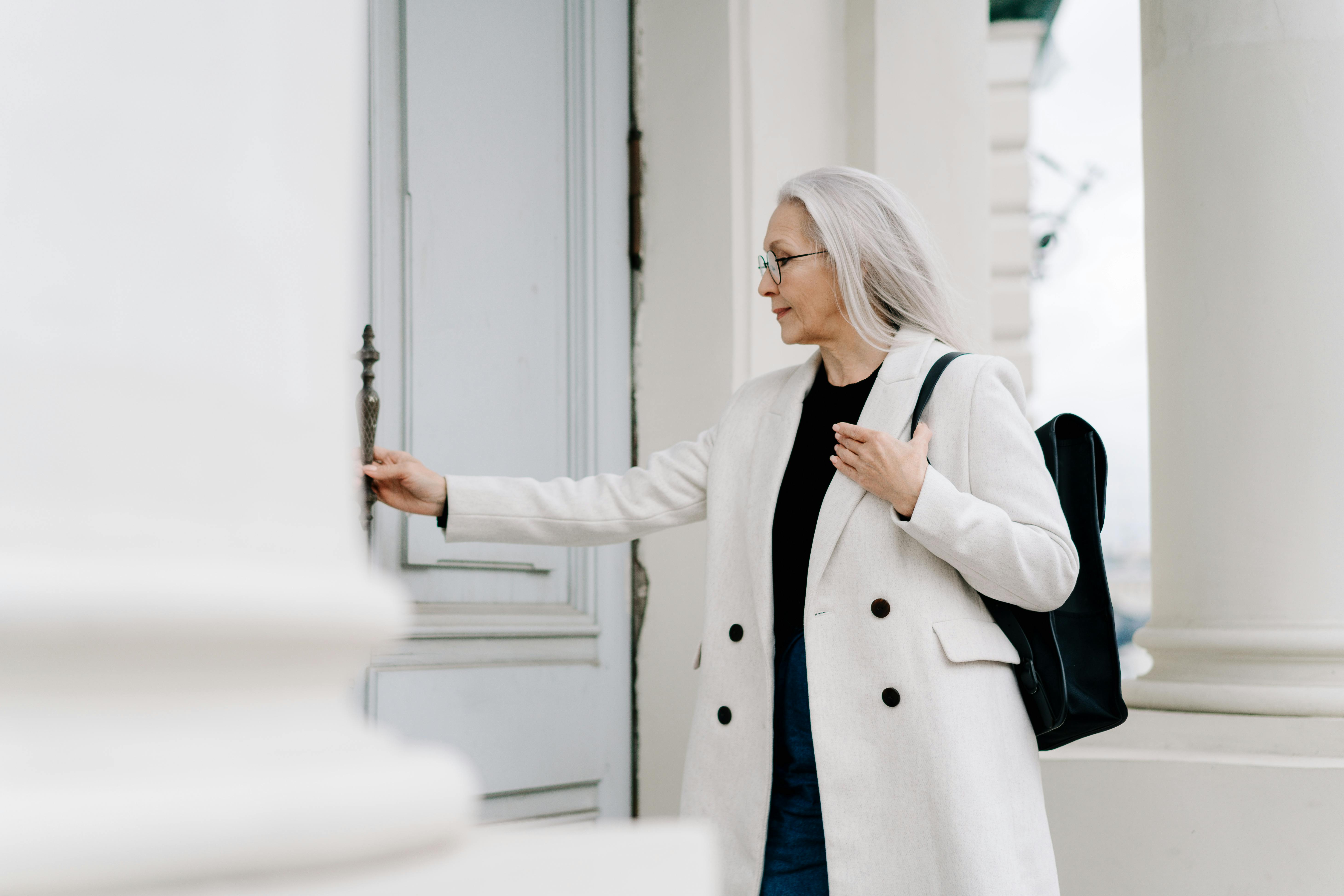Elderly Woman Opening a Door · Free Stock Photo