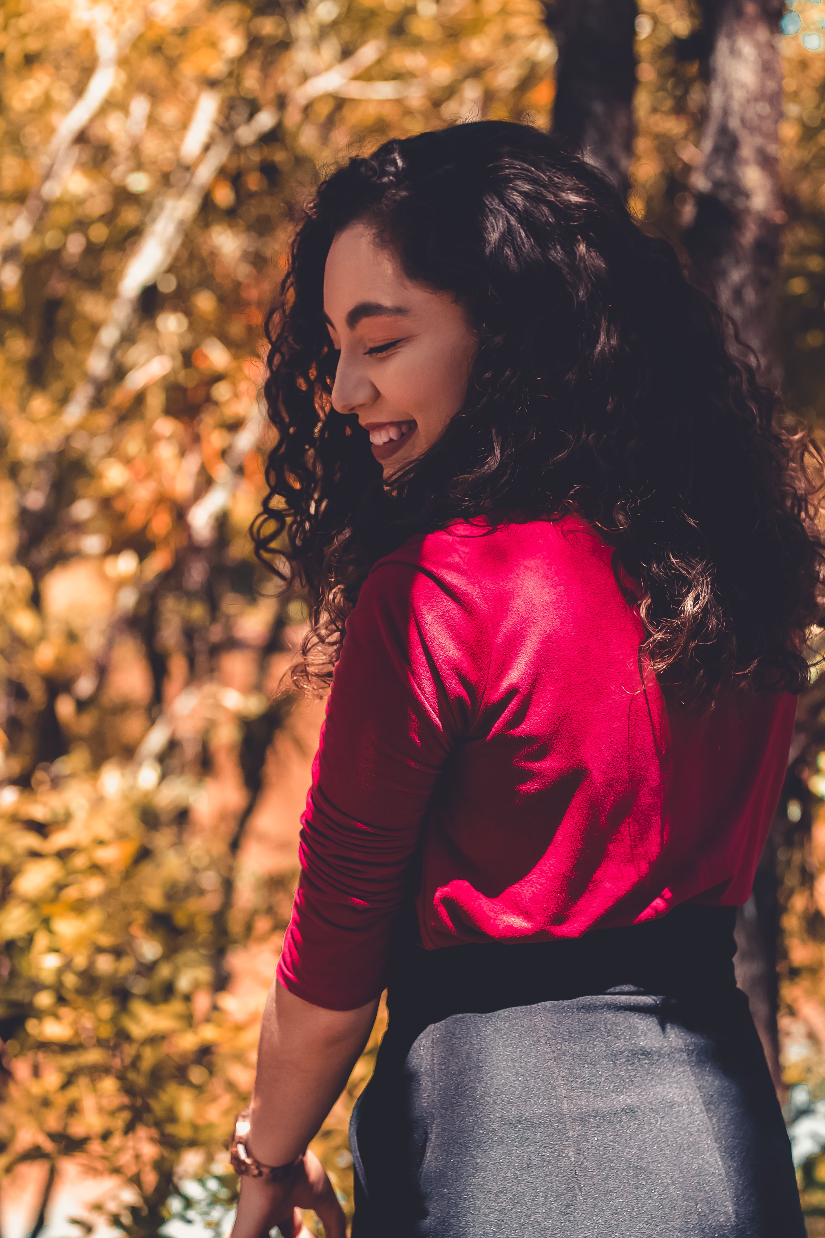 Woman Looking Over Her Shoulder Smiling in Black Off Shoulder Blouse ...
