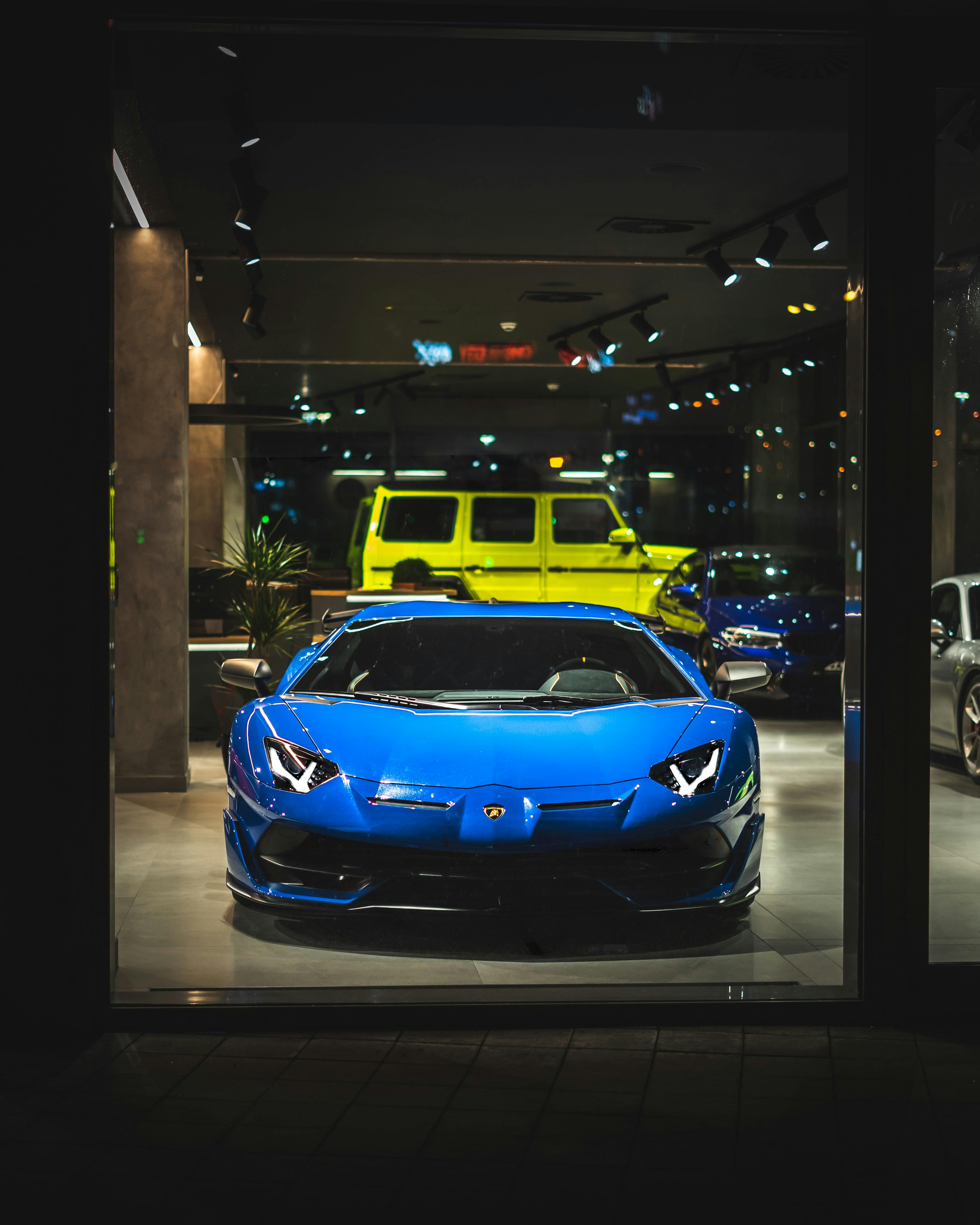 Blue Car Displayed Behind a Glass Window · Free Stock Photo