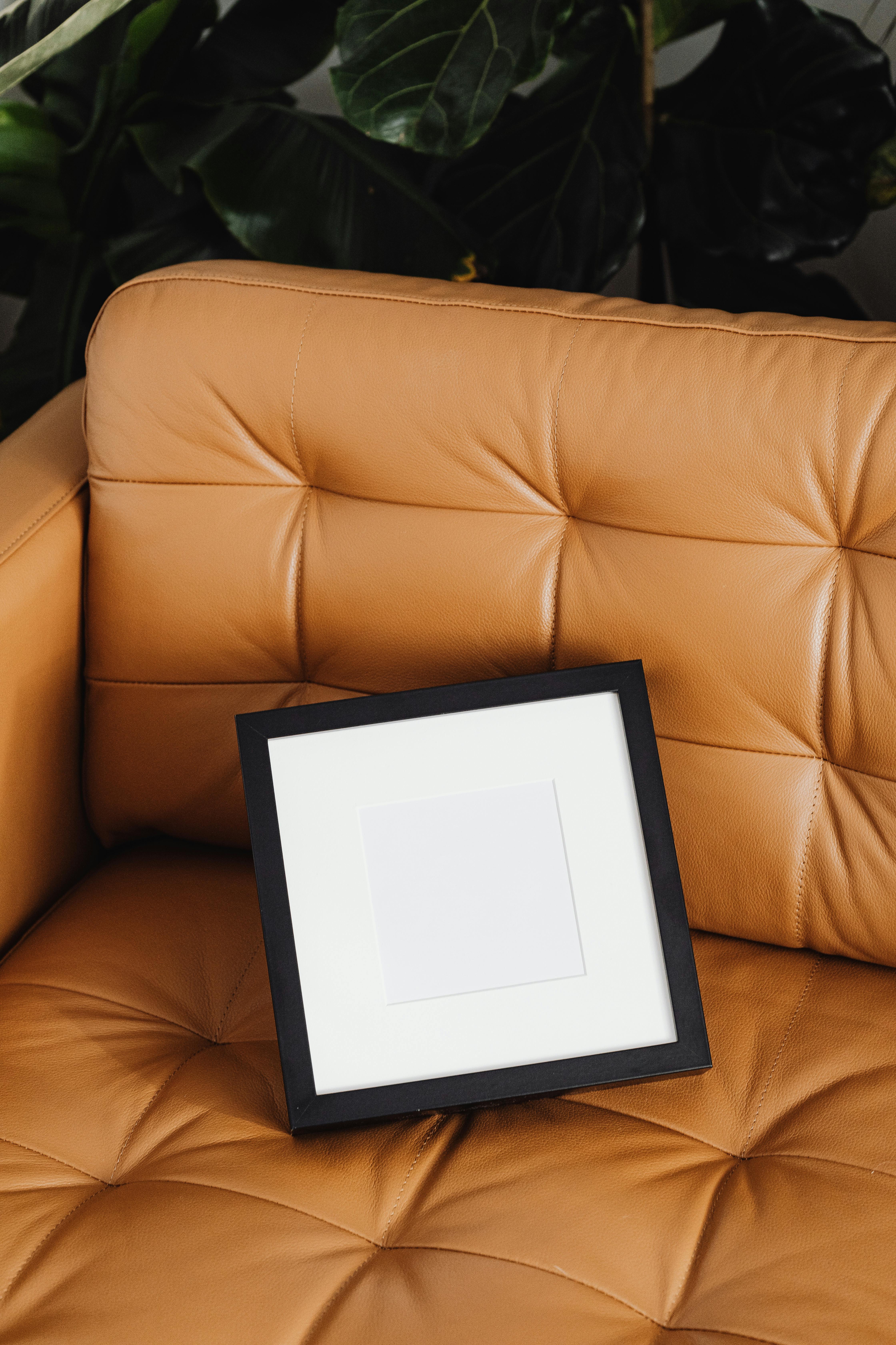 A Frame on a Brown Couch · Free Stock Photo