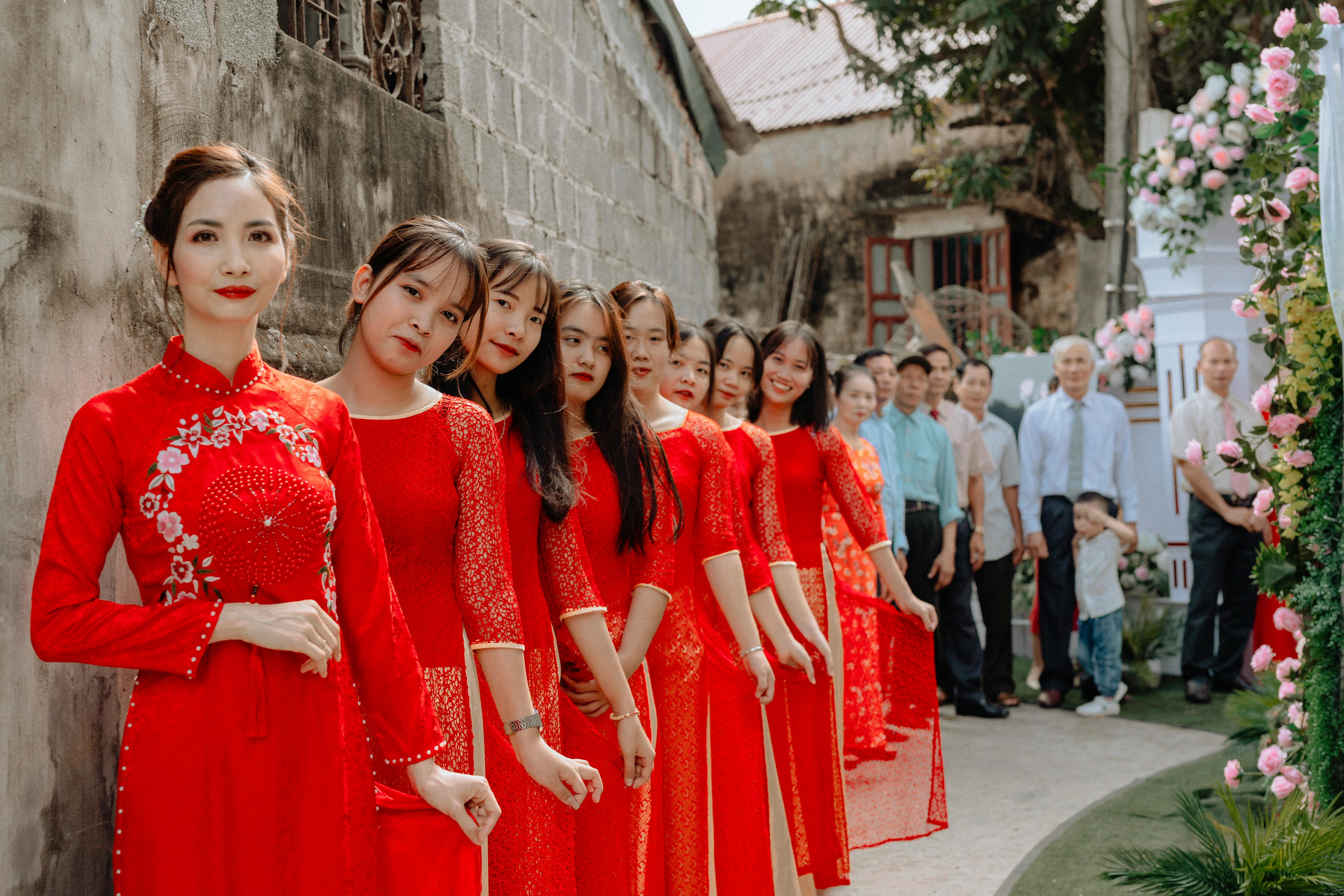 A Group of Women in Red Long Sleeve Dress Standing · Free Stock Photo