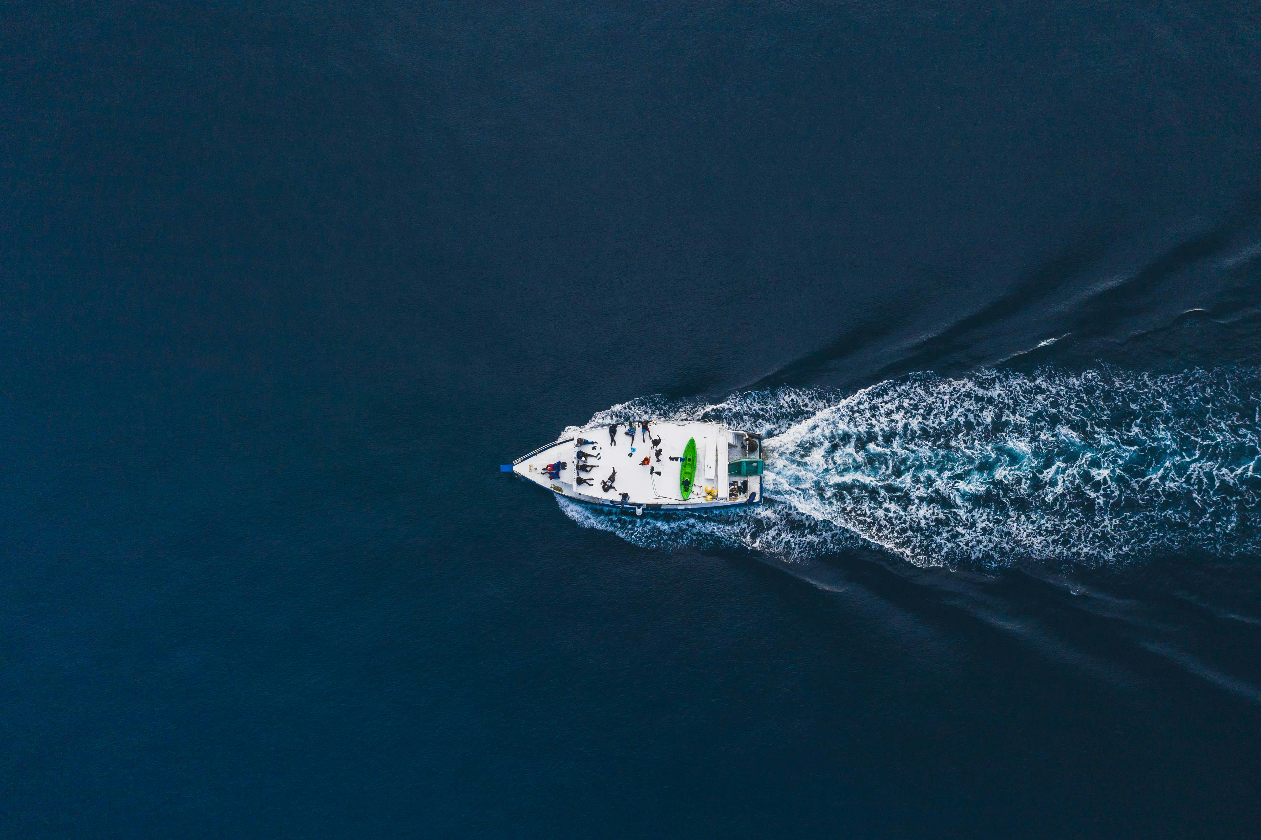 Boat floating in open sea · Free Stock Photo