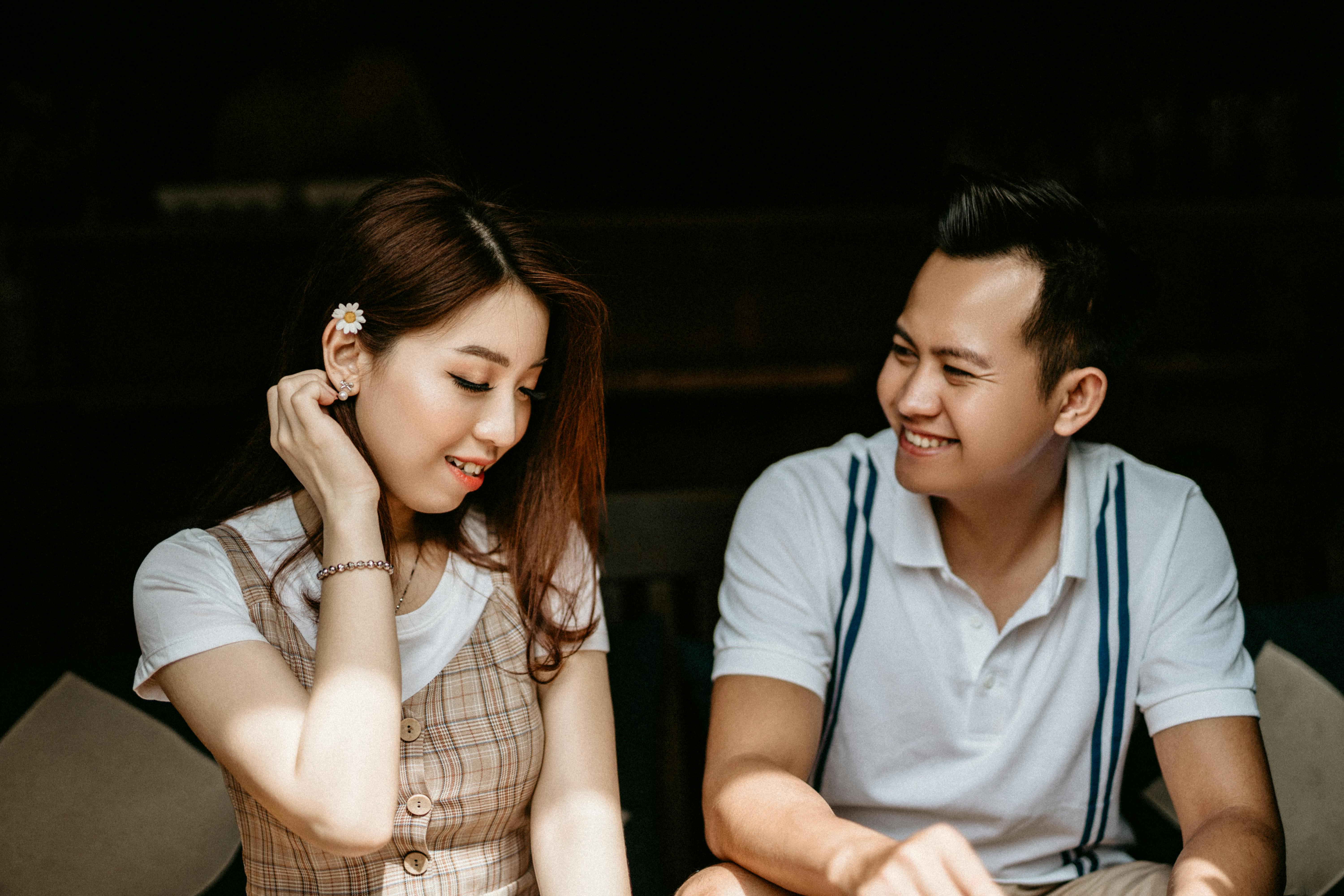 Happy Asian couple talking in cafe · Free Stock Photo