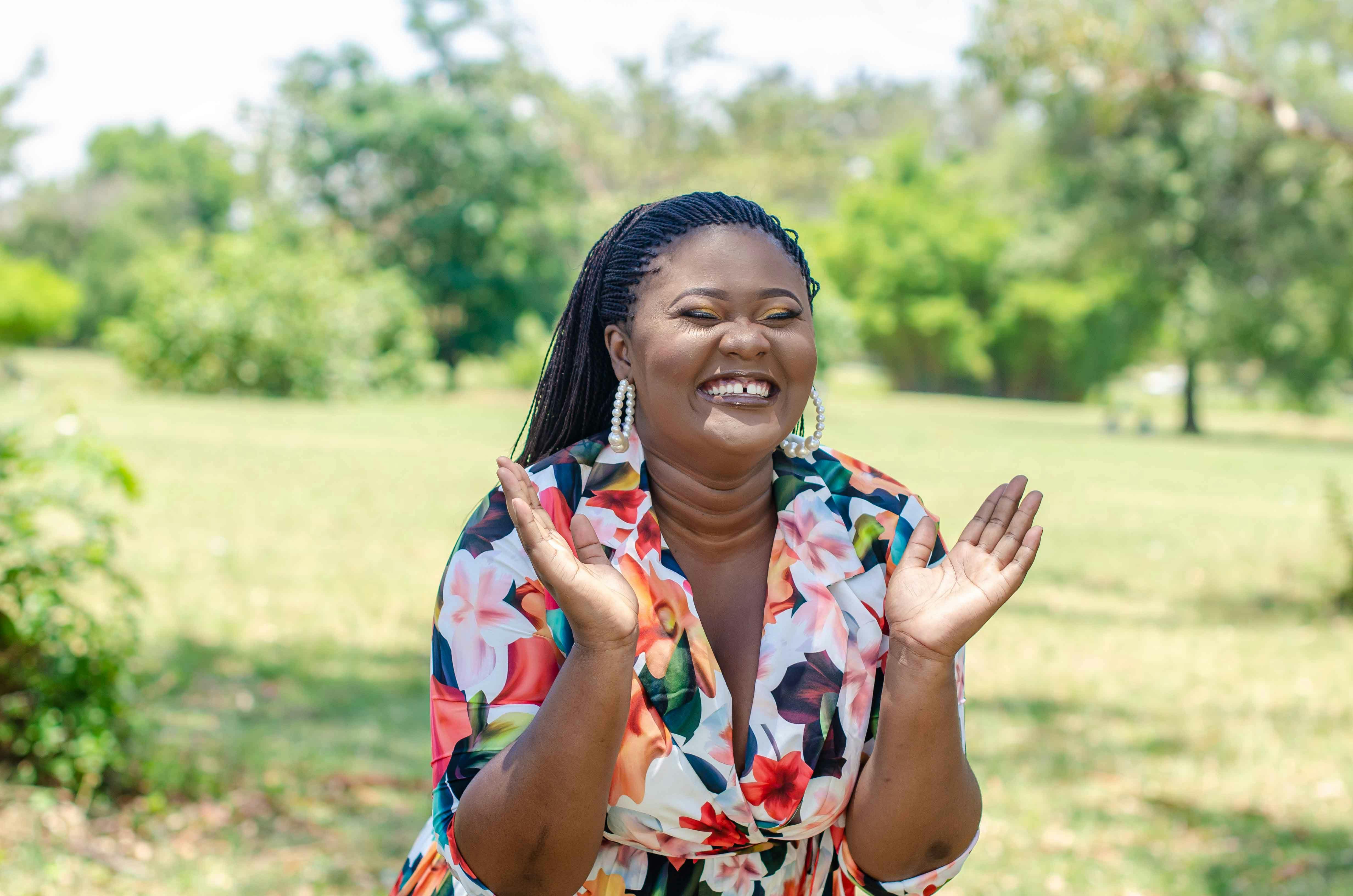 Selective Focus Photo of a Woman in a Floral Top Clapping while Smiling ...