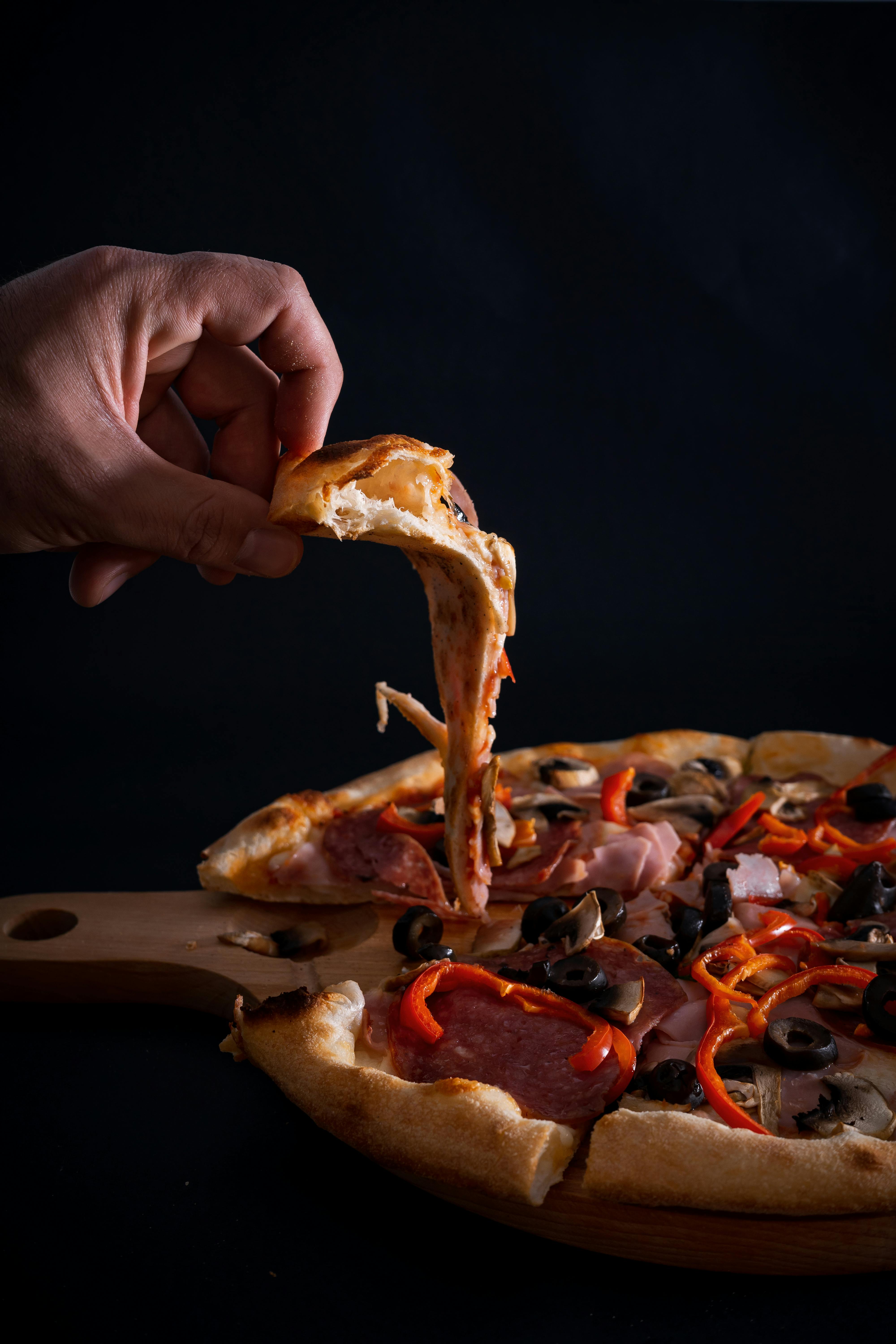Person Holding Pizza on a Box · Free Stock Photo