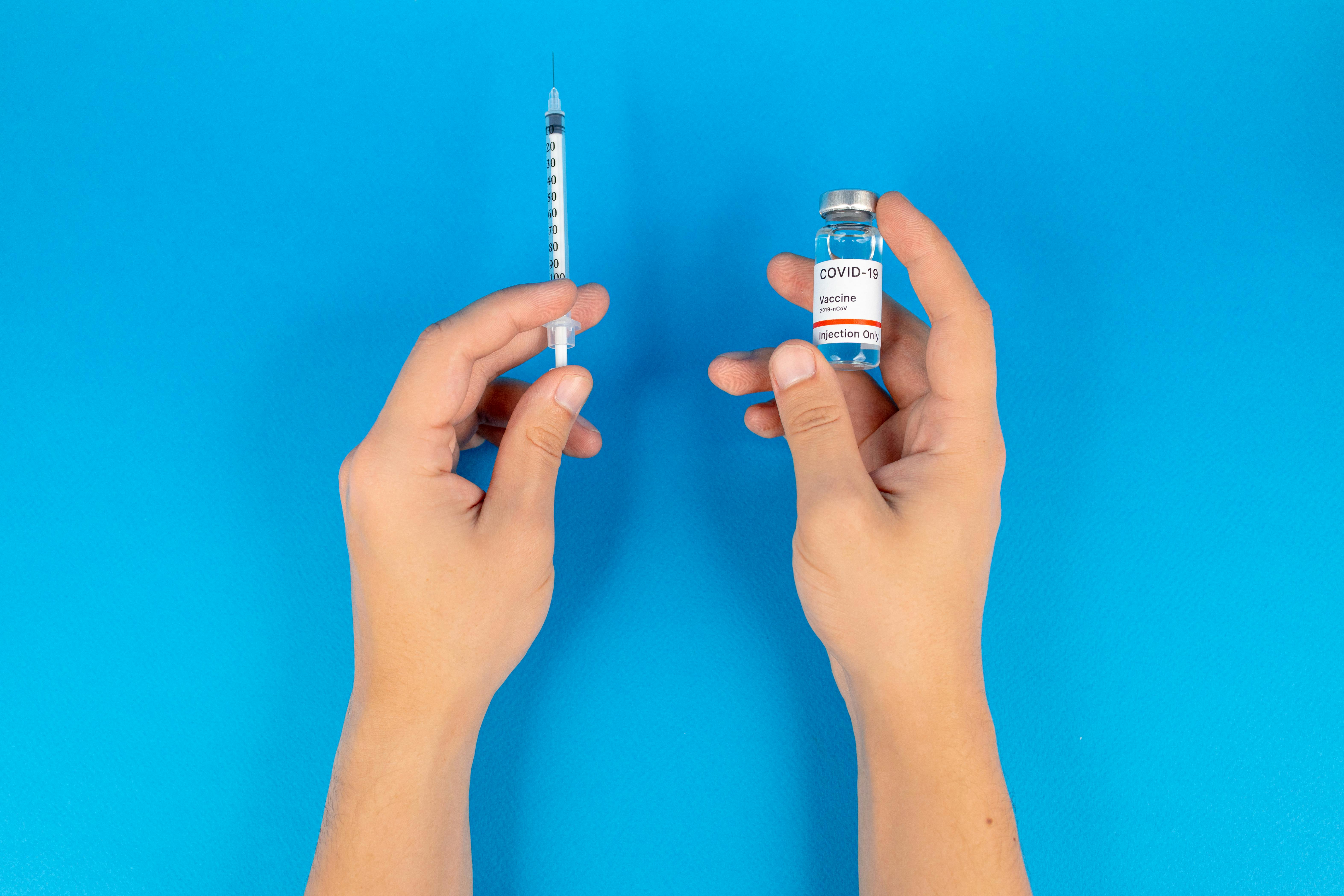 Man Touching an IV Injection Training Pad · Free Stock Photo