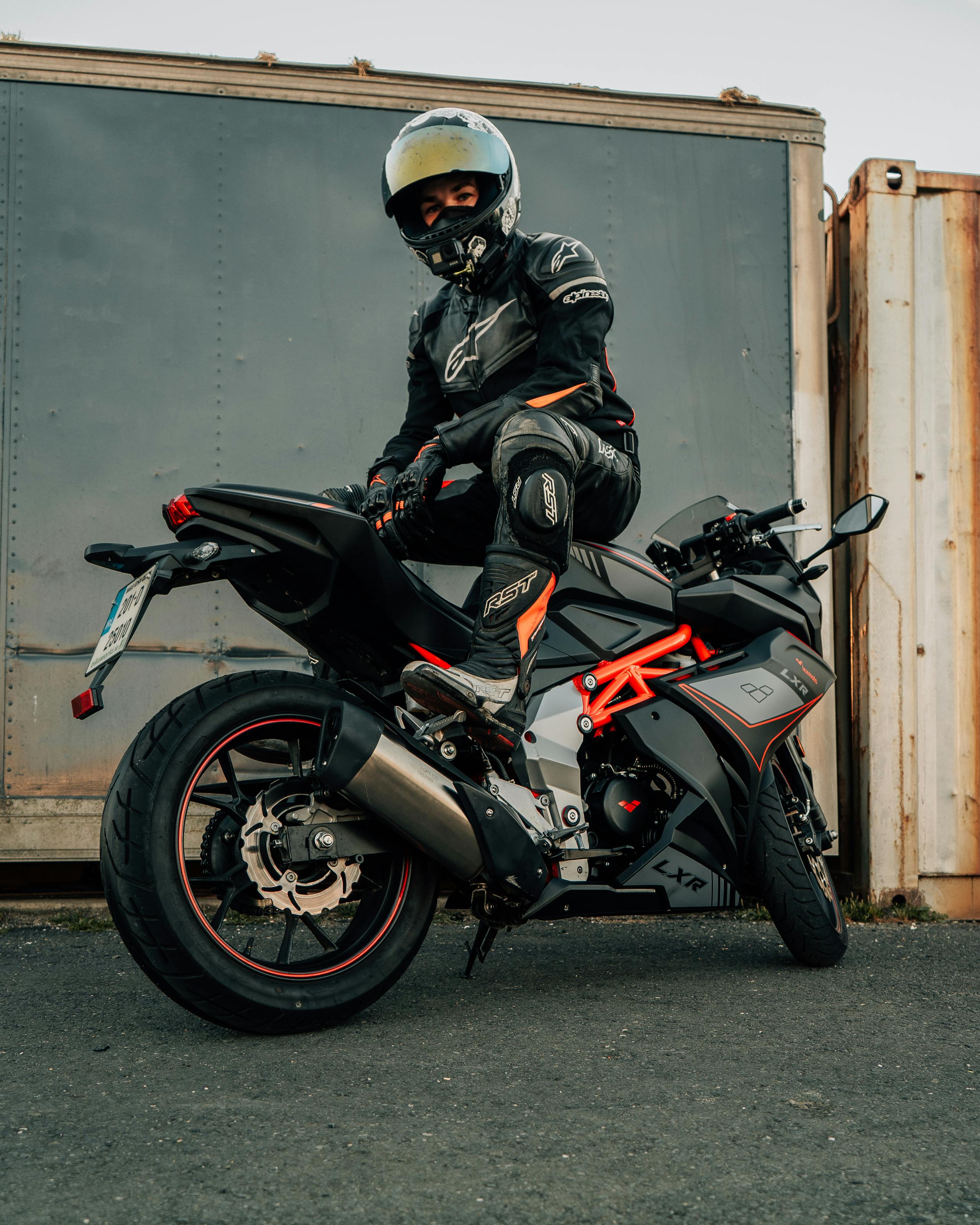 Man Posing with Motorcycle on Street · Free Stock Photo