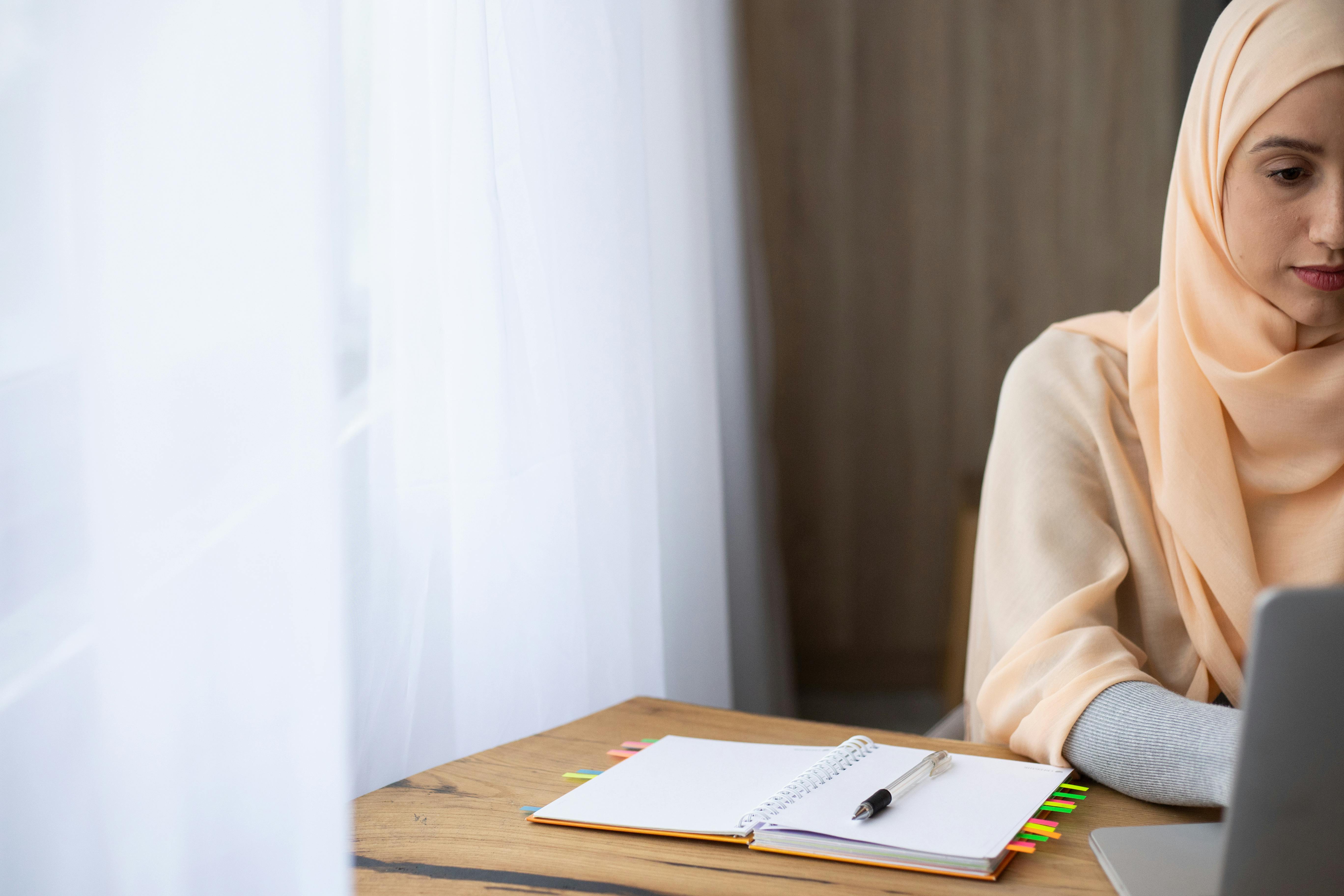 Muslim woman using laptop for work · Free Stock Photo