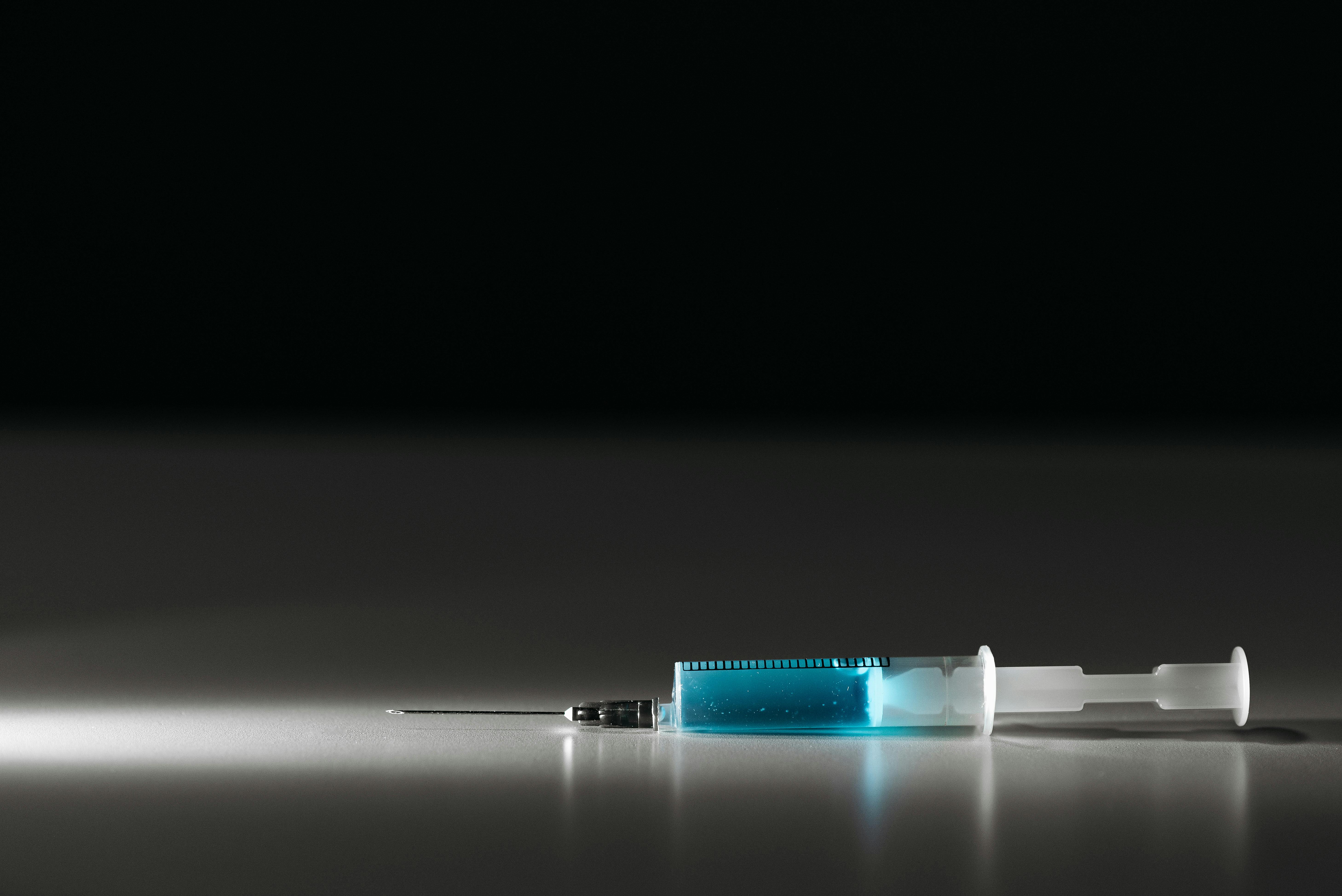 Close-Up Photo of a Syringe Containing a Blue Liquid · Free Stock Photo