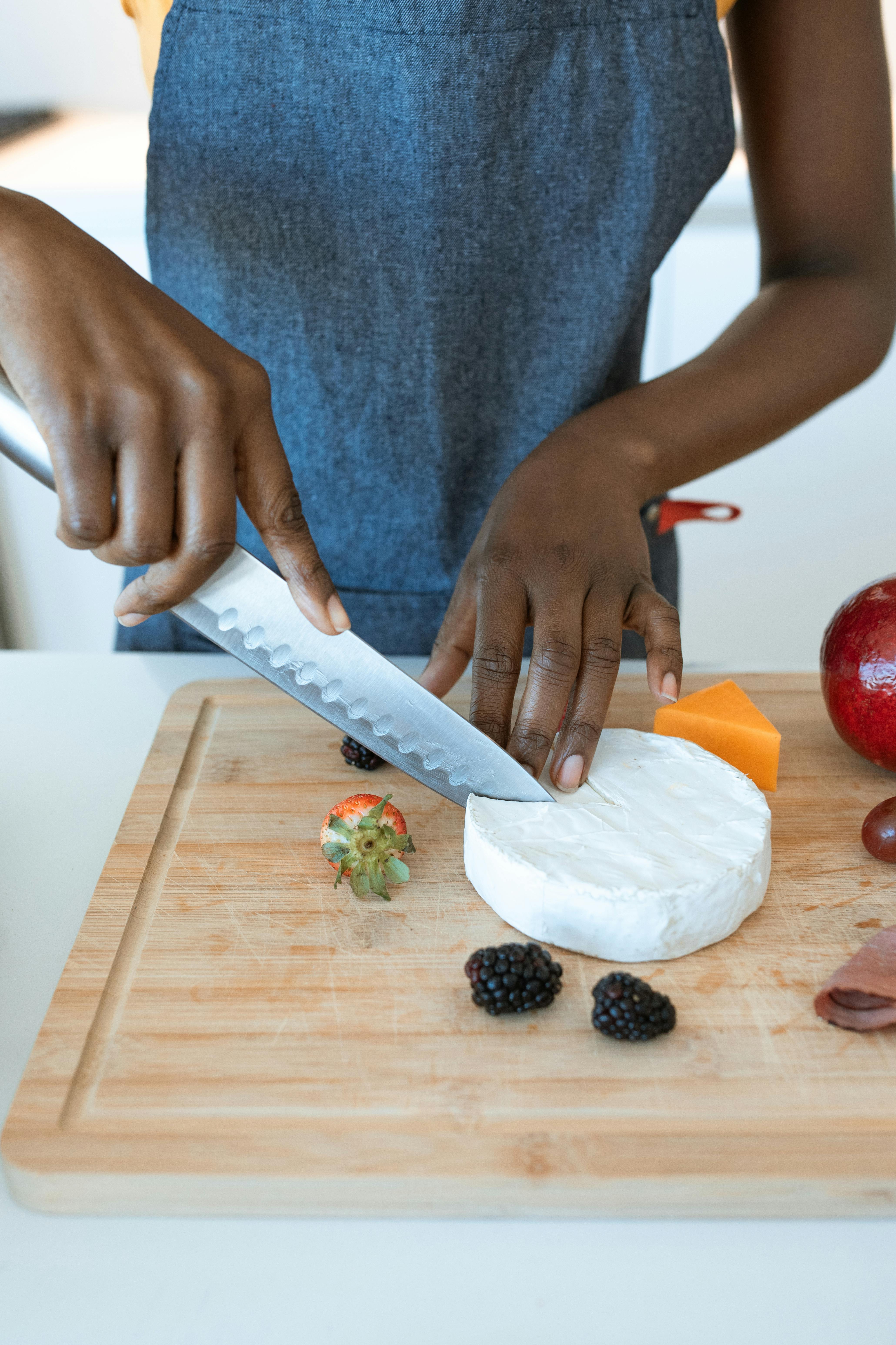 Woman Garnishing Serving Board and Platters on Table · Free Stock Photo