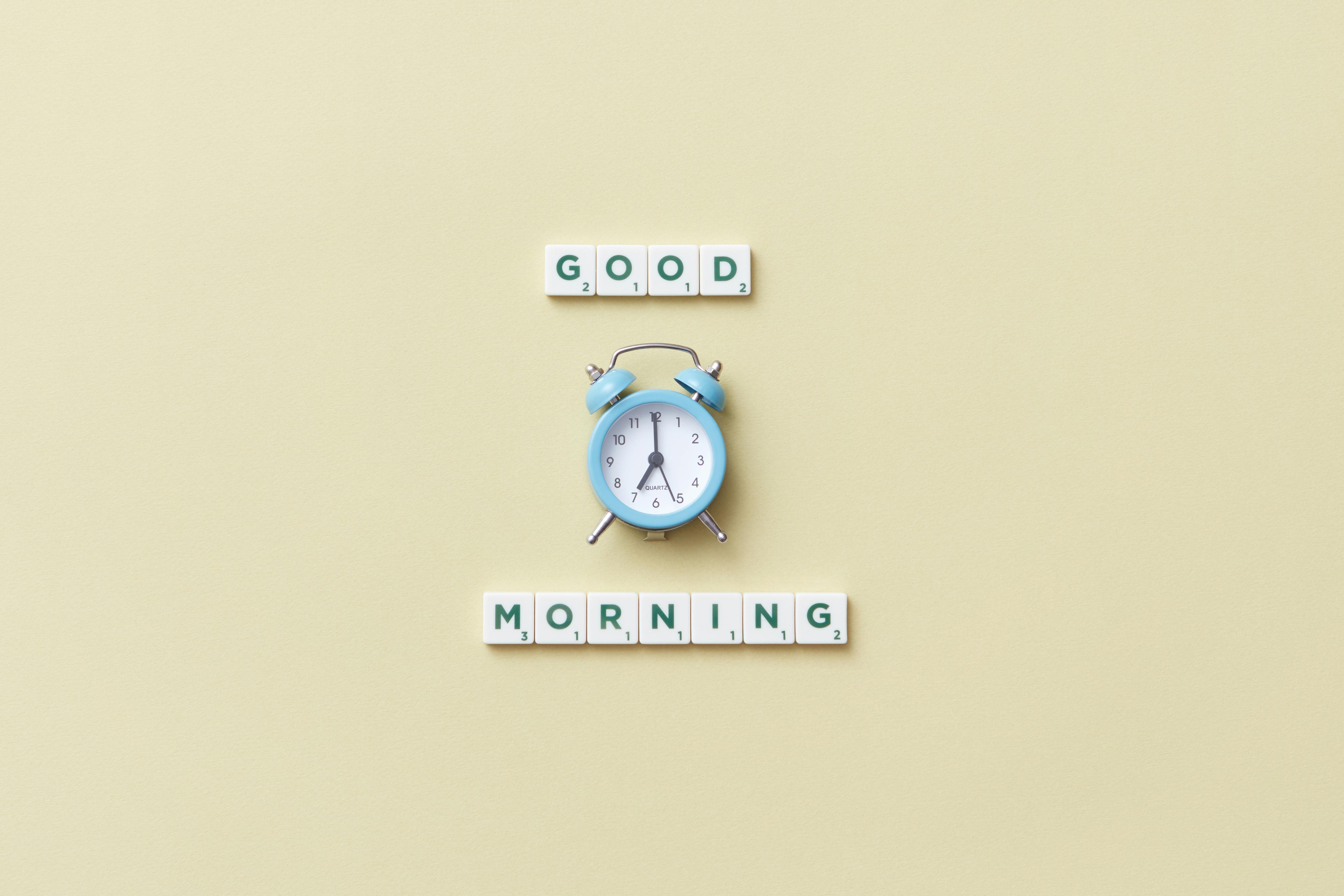 A Phrase Spelled with Scrabble Tiles and an Alarm Clock · Free Stock Photo