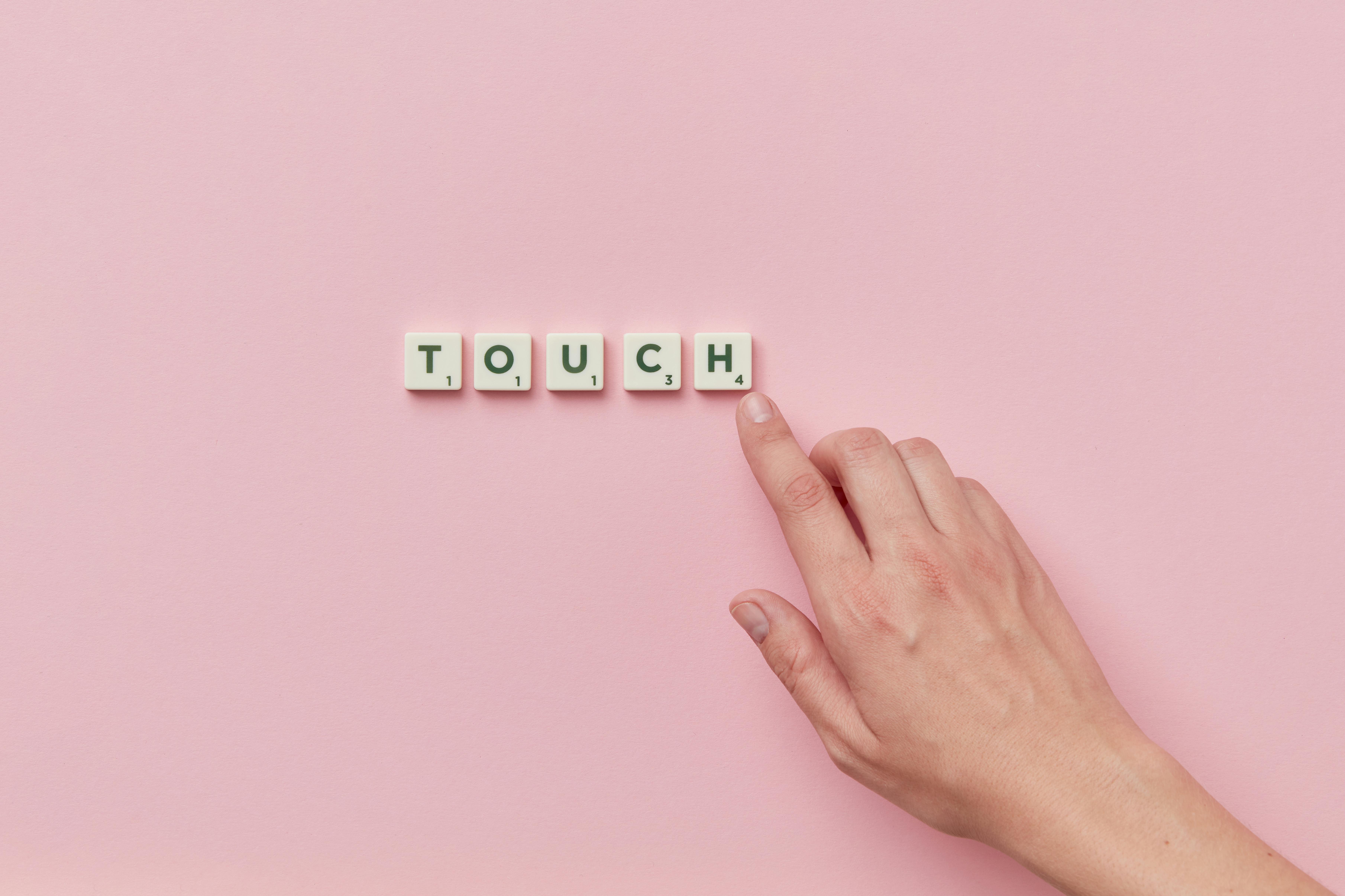 Person Touching White Plastic Scrabble Tile · Free Stock Photo