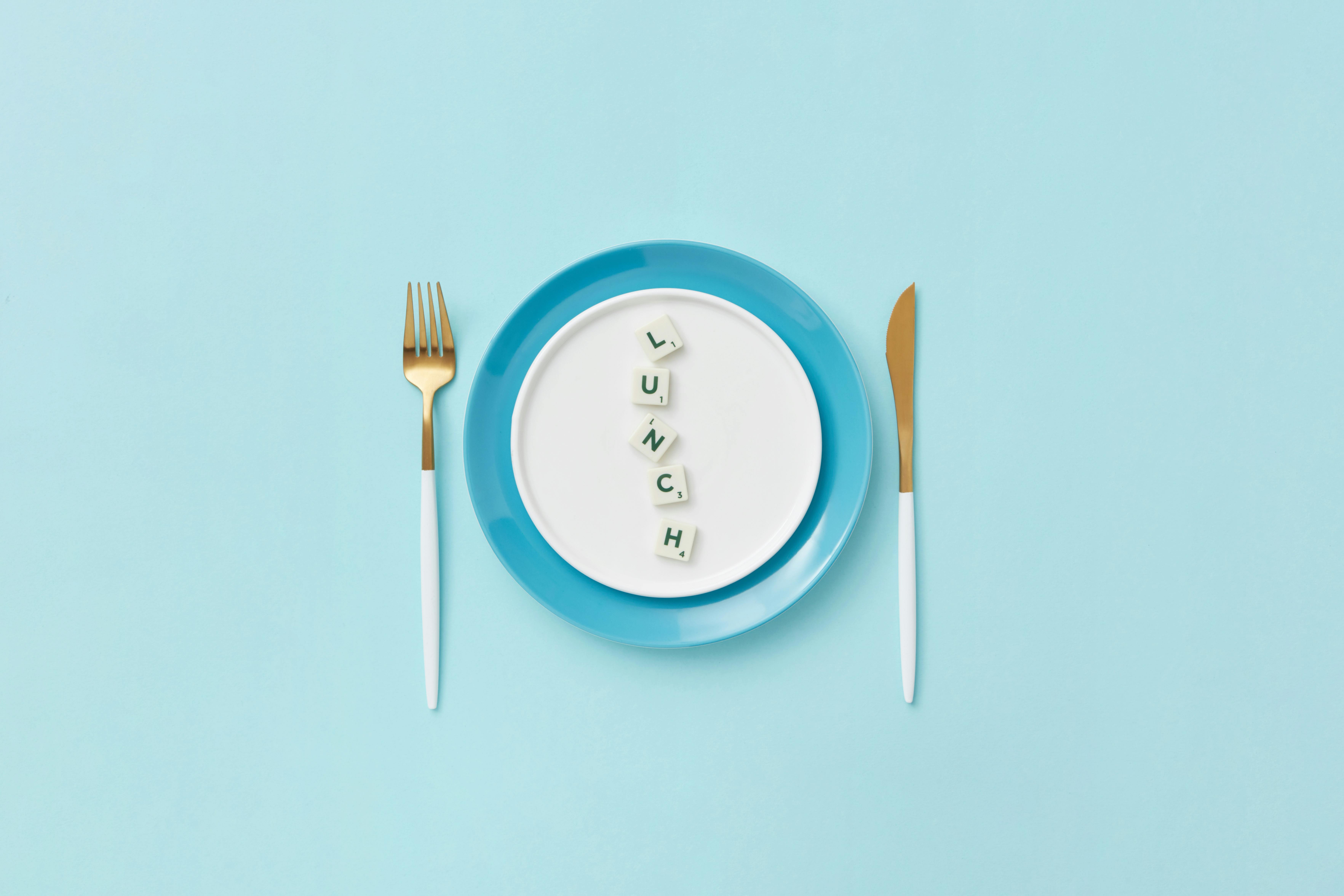 Lunch Text on Plate on Blue Background · Free Stock Photo