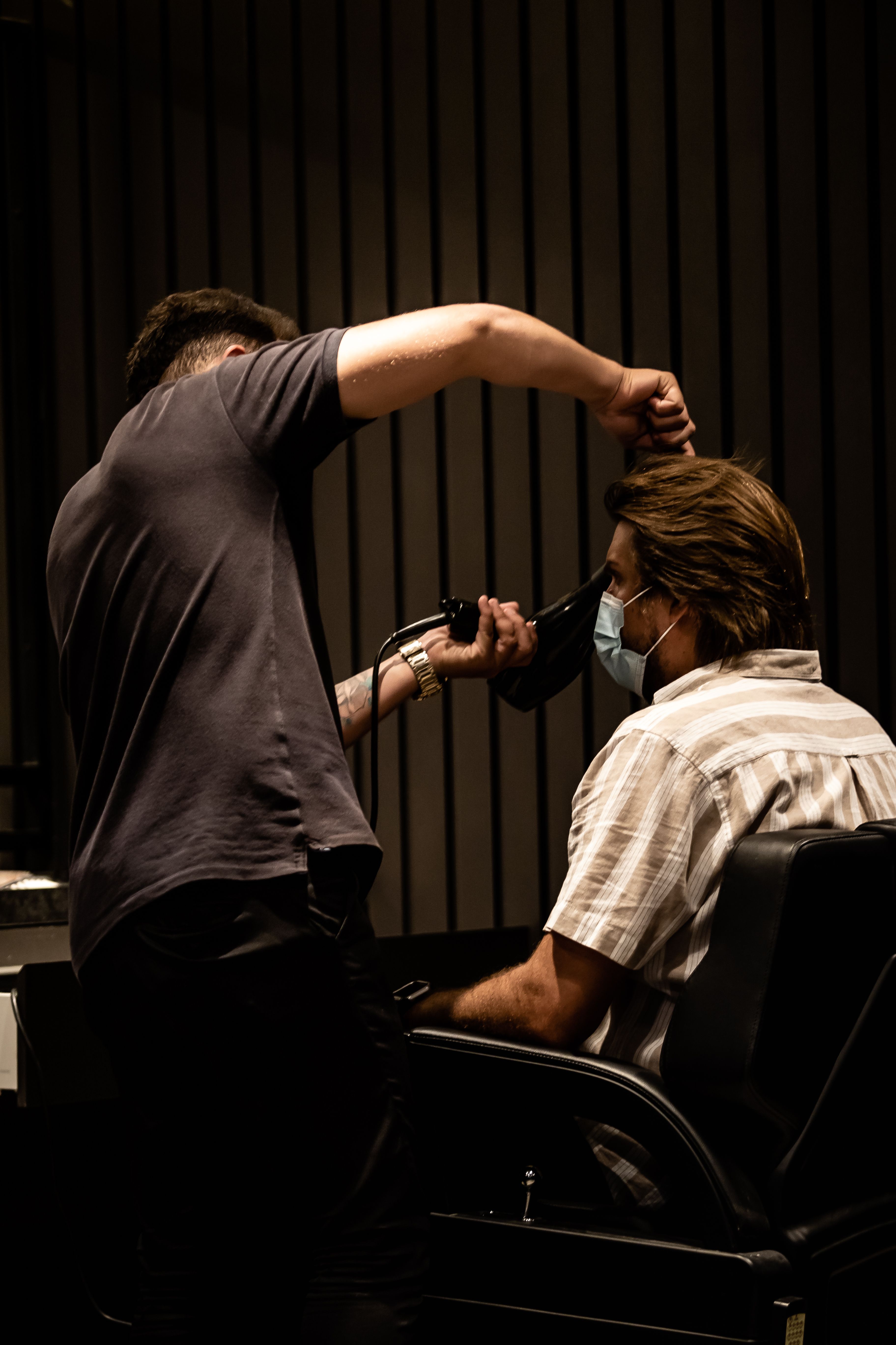 Person Getting Haircut Besides Red Telephone Booth · Free Stock Photo