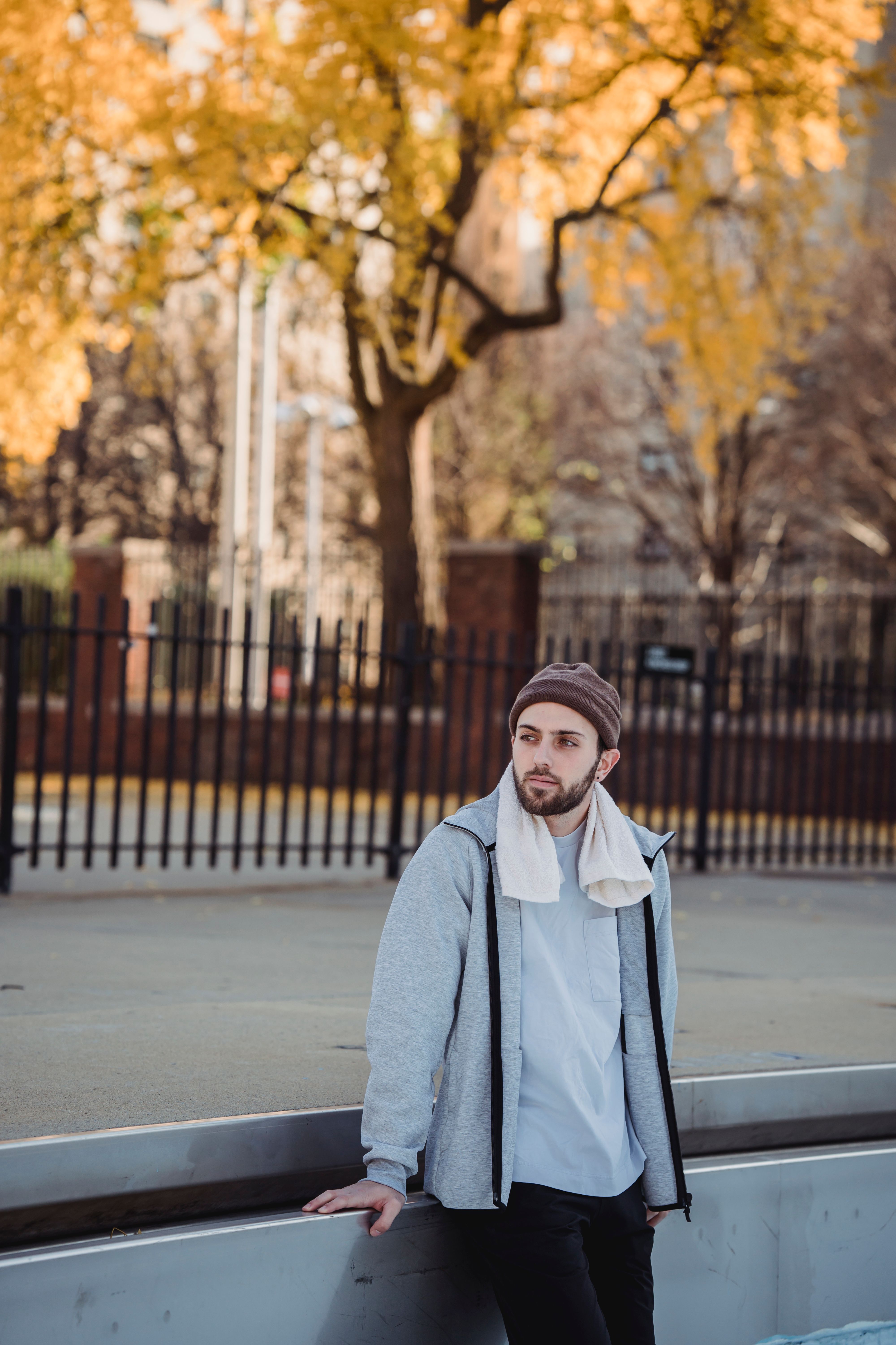 Guy in city street near fence · Free Stock Photo