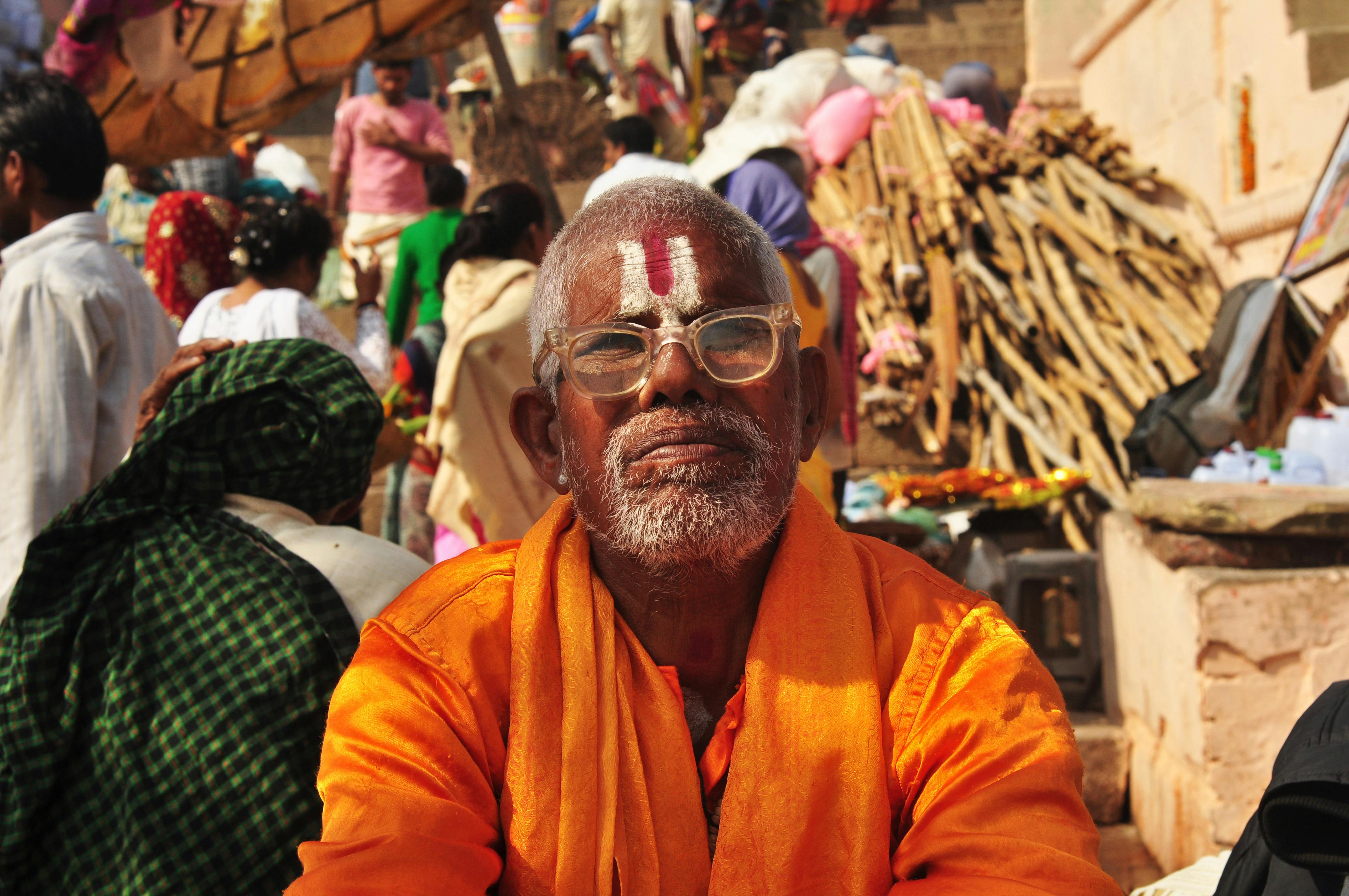 Close-Up Shot of an Elderly Man in Orange Robe · Free Stock Photo