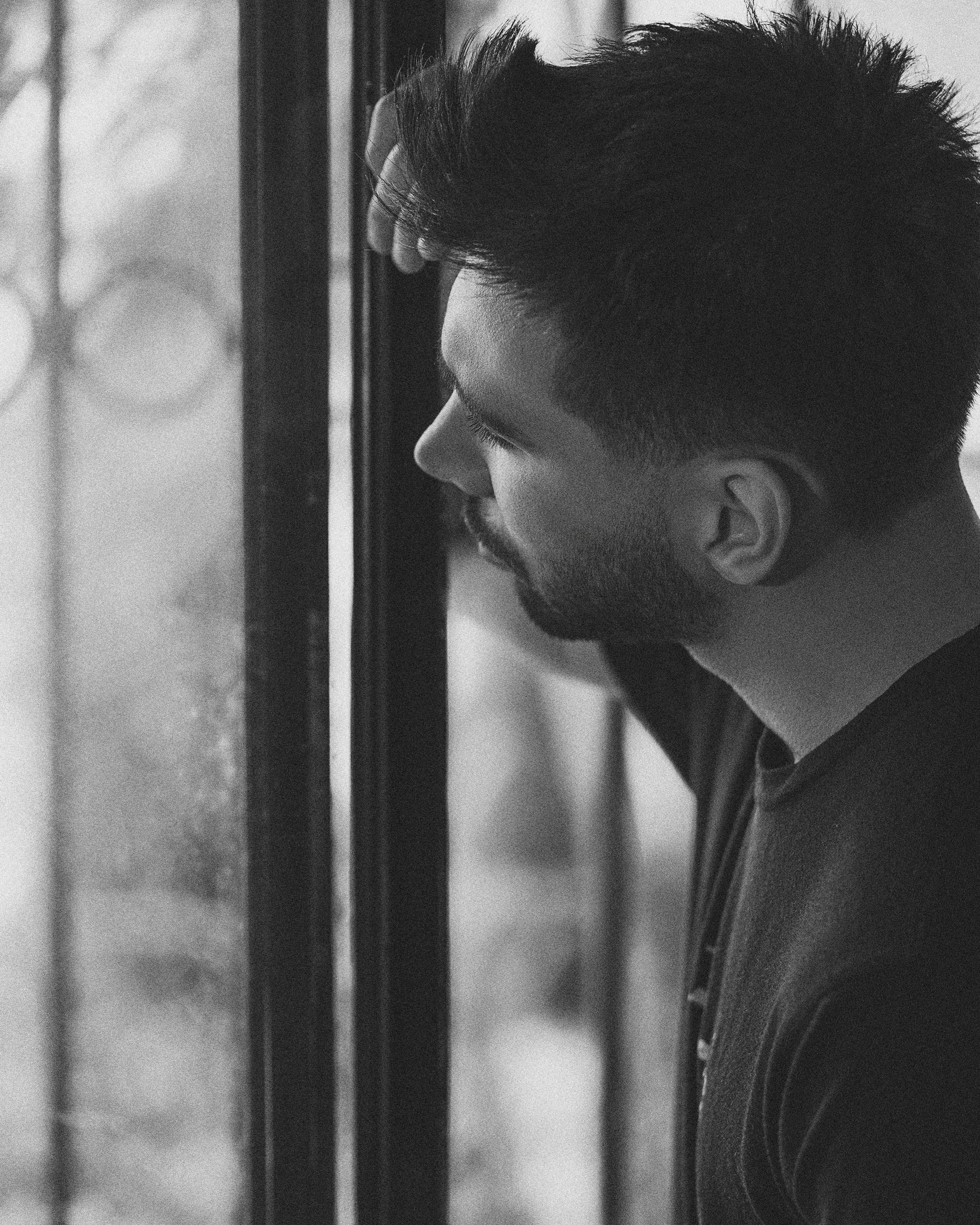 Grayscale Photo of a Man Looking at the Window · Free Stock Photo