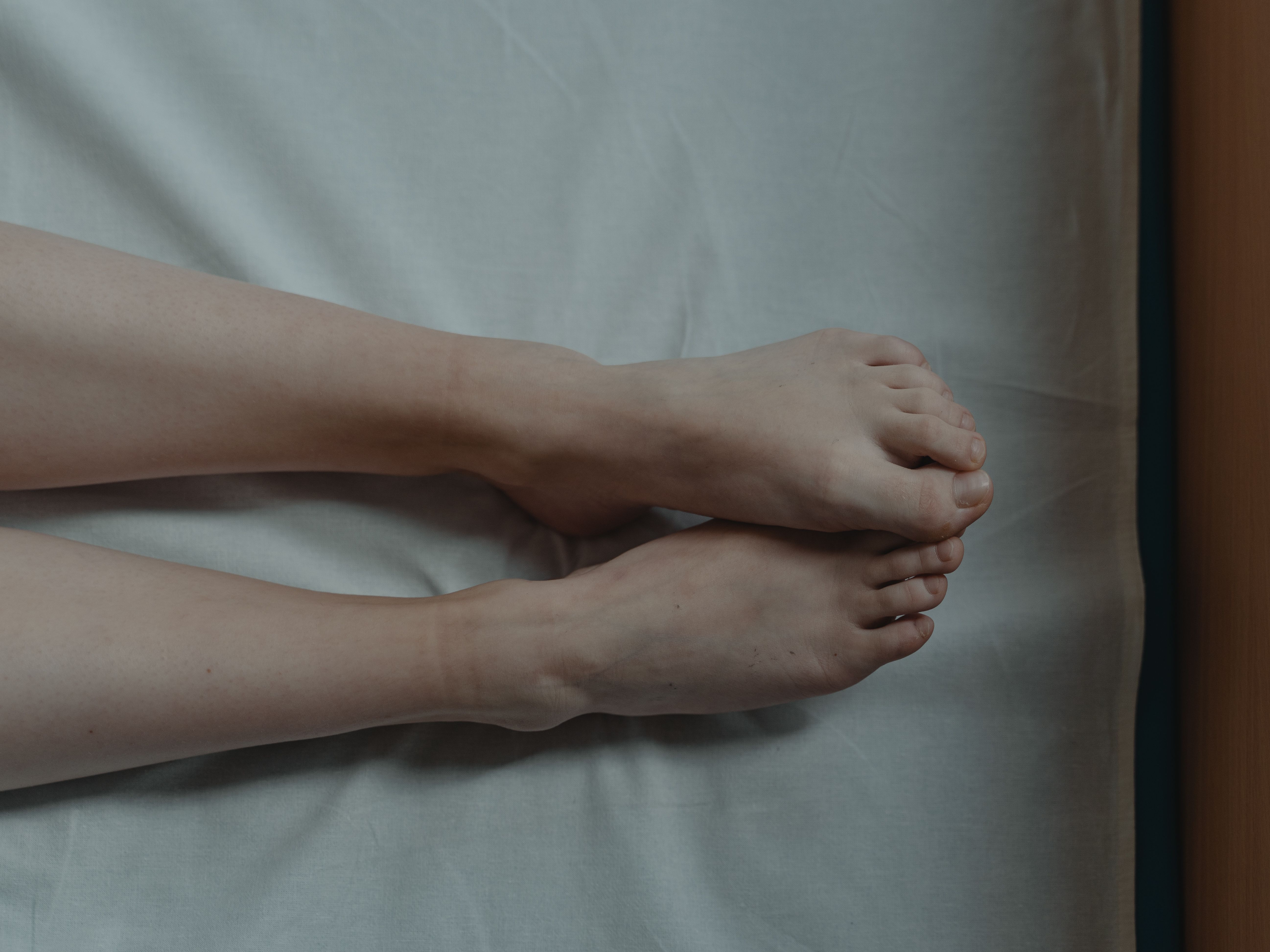 Feet on White Textile · Free Stock Photo