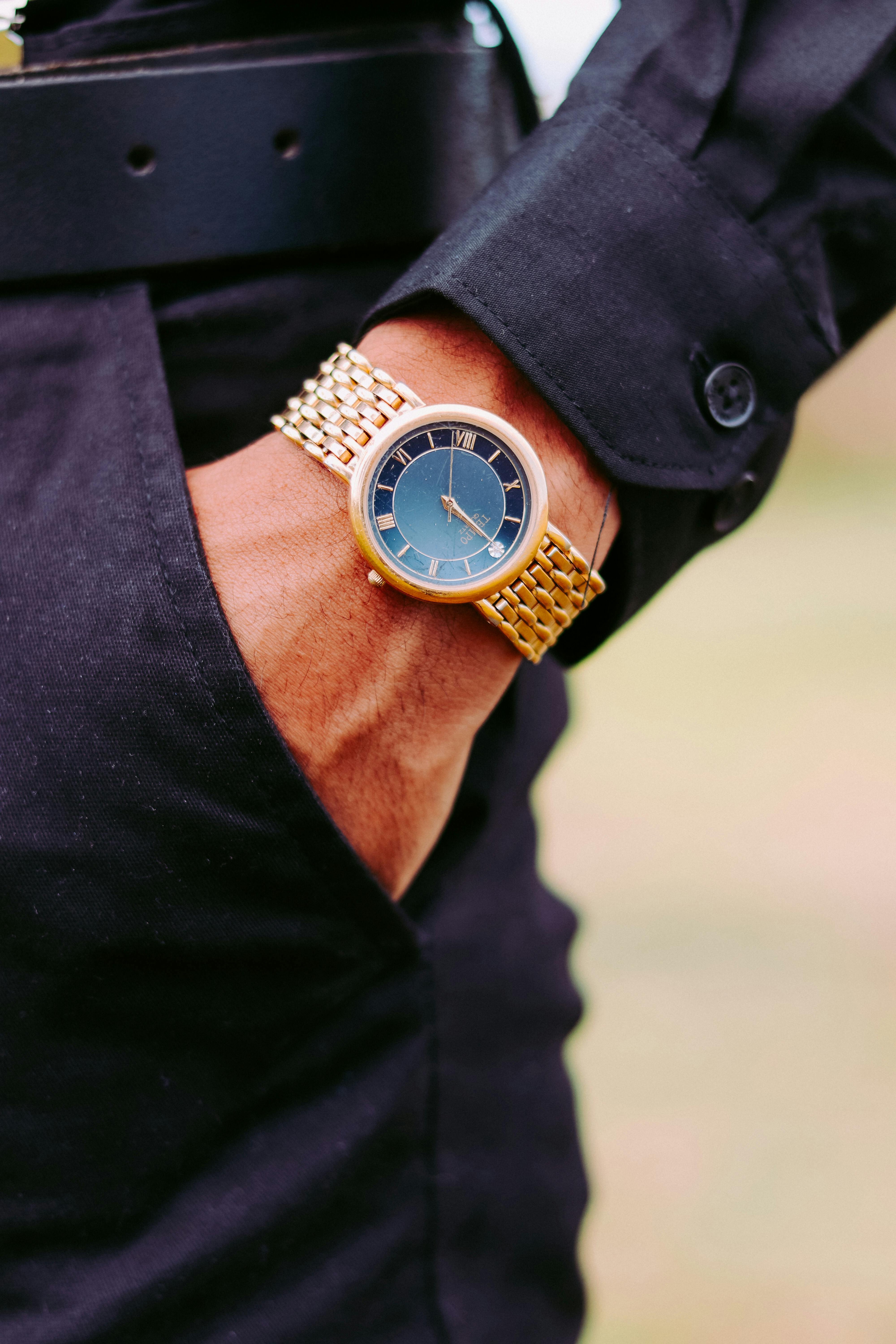 Person's Hand in Pocket Wearing Golden Watch · Free Stock Photo