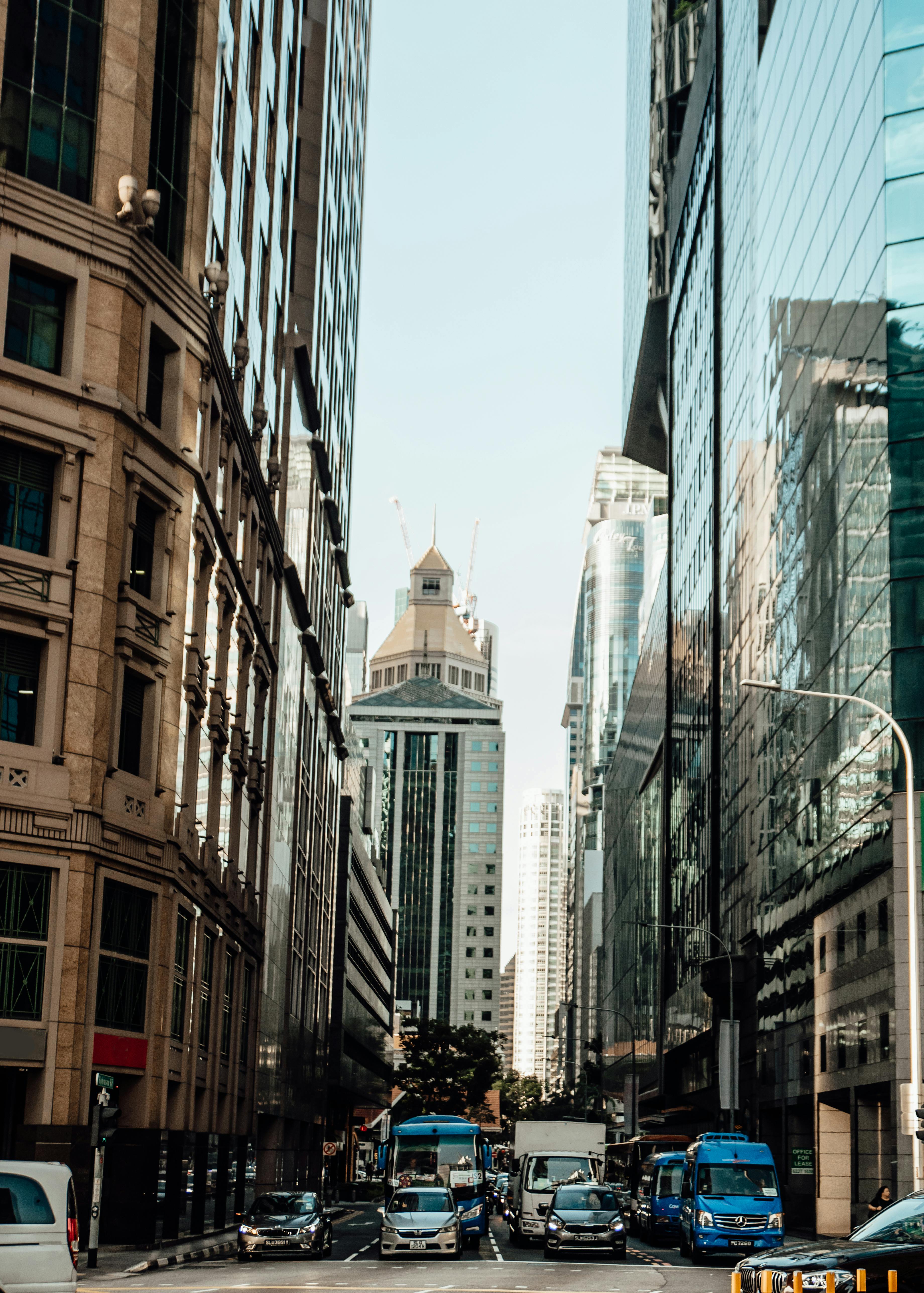 People Walking on Street Between High Rise Buildings · Free Stock Photo