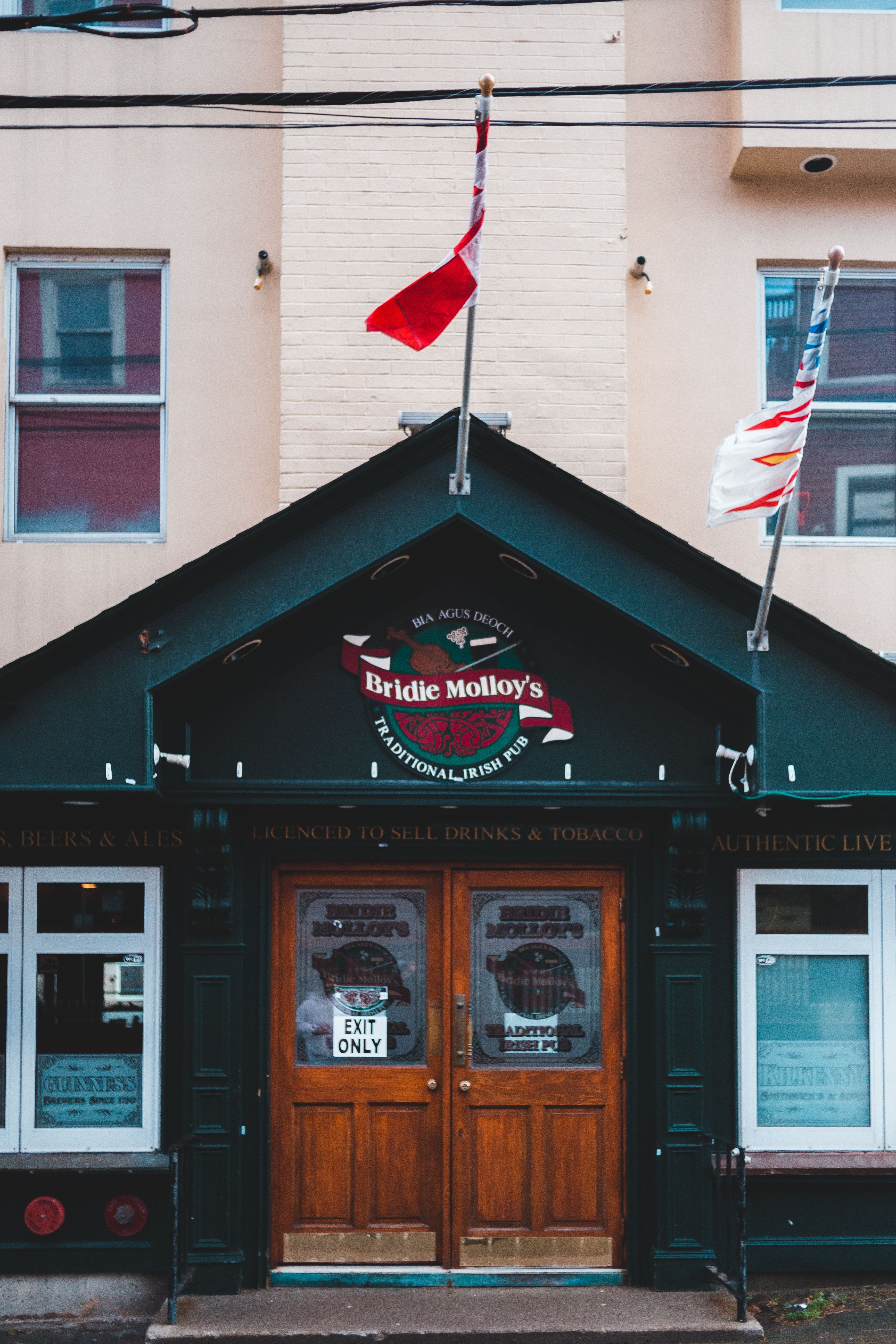 Exterior of modern building with flags · Free Stock Photo