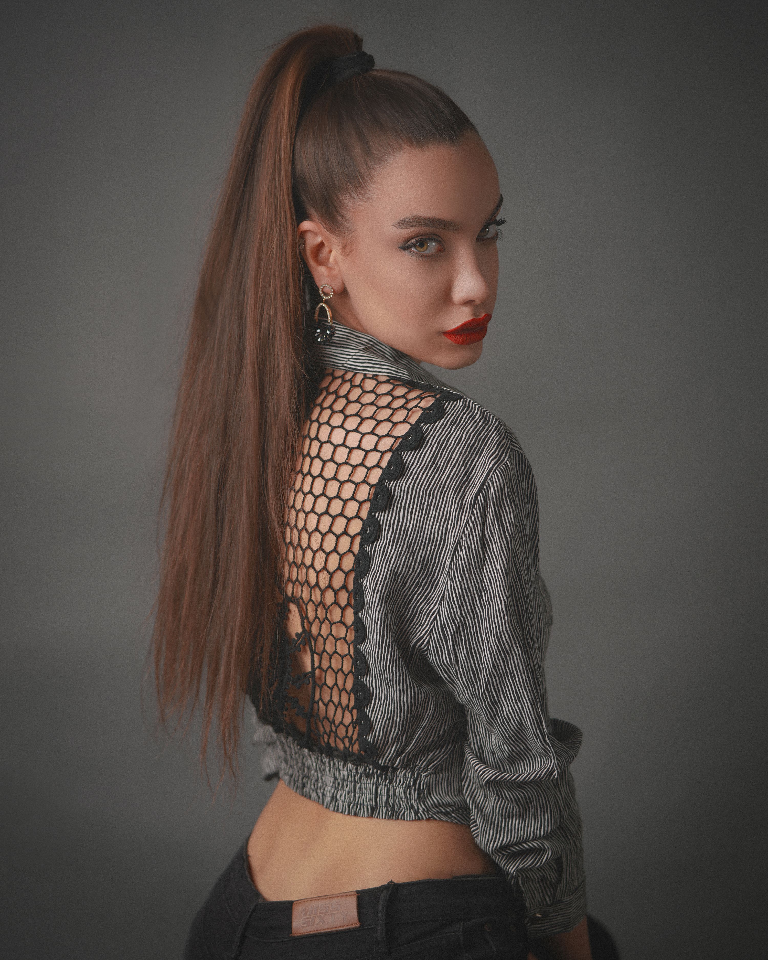 A Beautiful Woman in Pony Tail Hair Posing at the Camera · Free Stock Photo